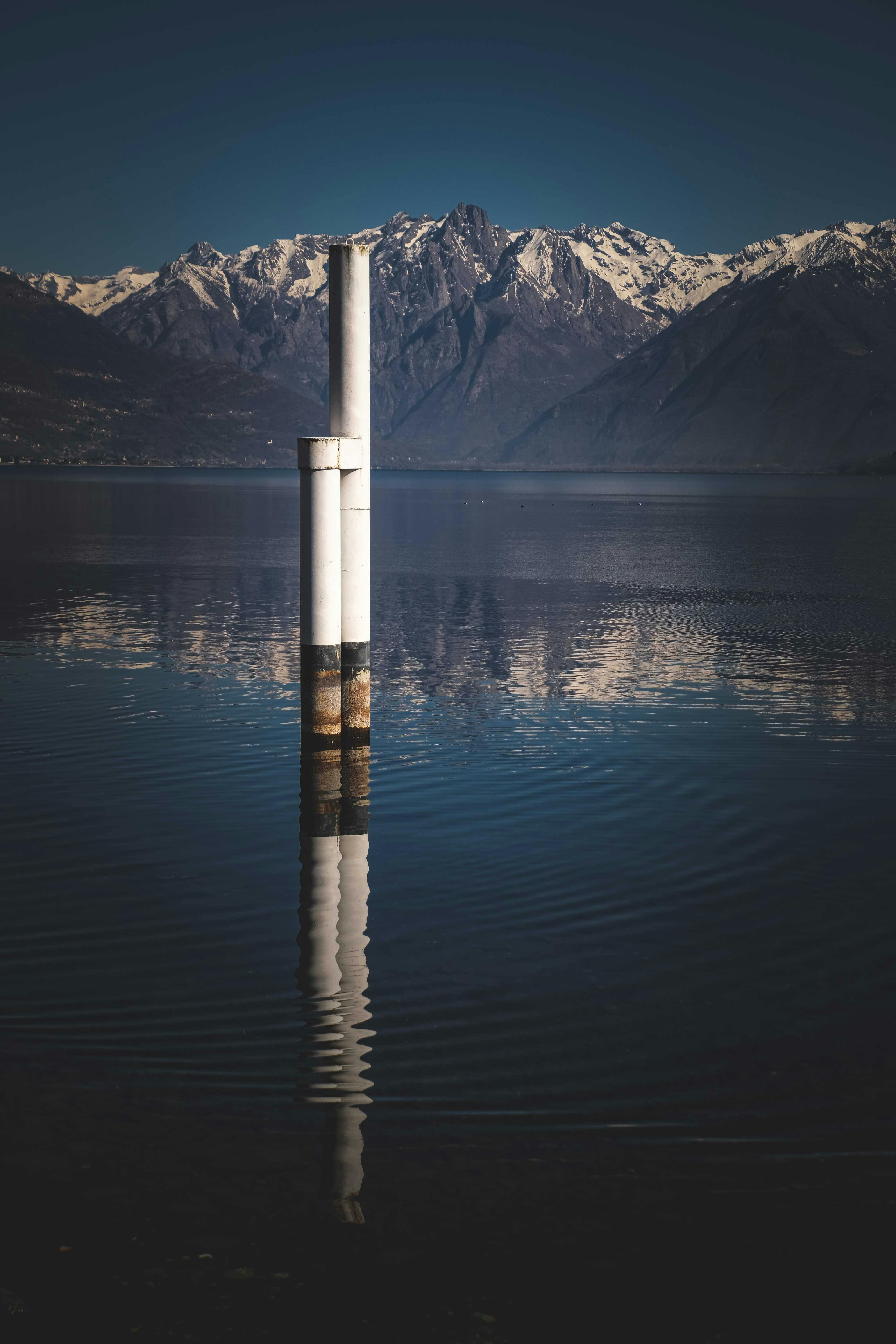 Massive pipes on calm water on river · Free Stock Photo