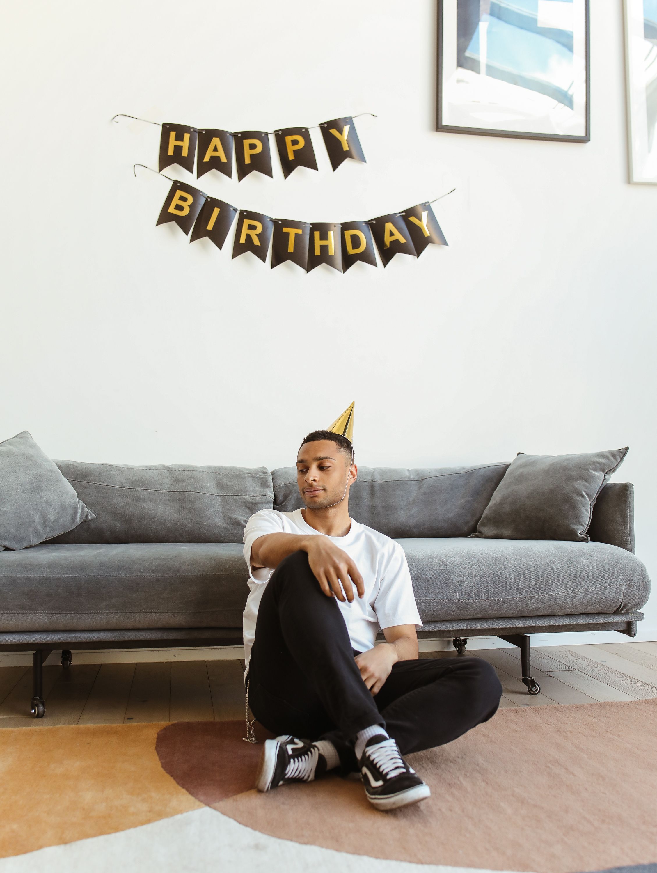 Man Wearing a Party Hat Sitting on the Floor · Free Stock Photo