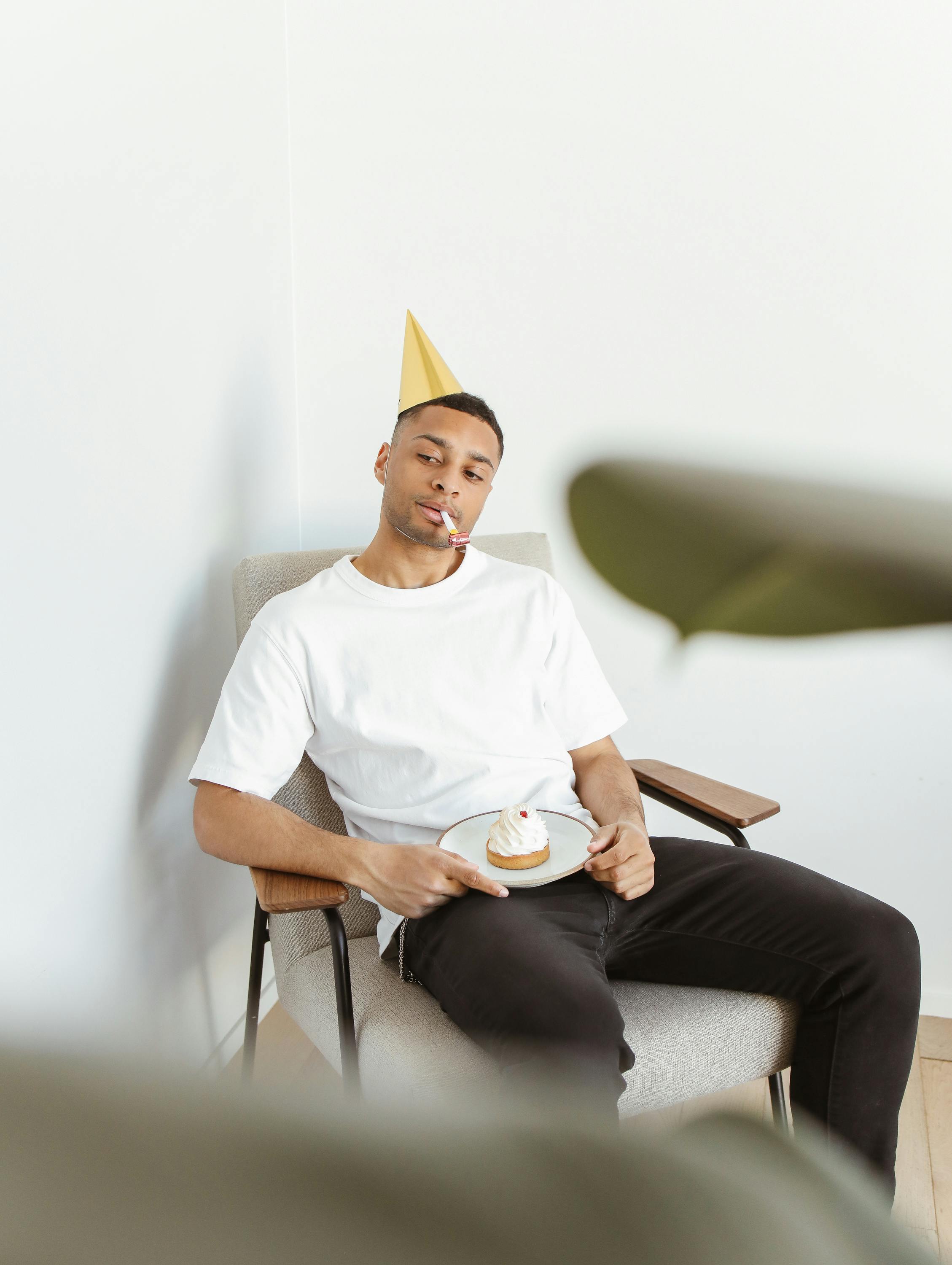A Man Sitting Wearing Party Hat · Free Stock Photo