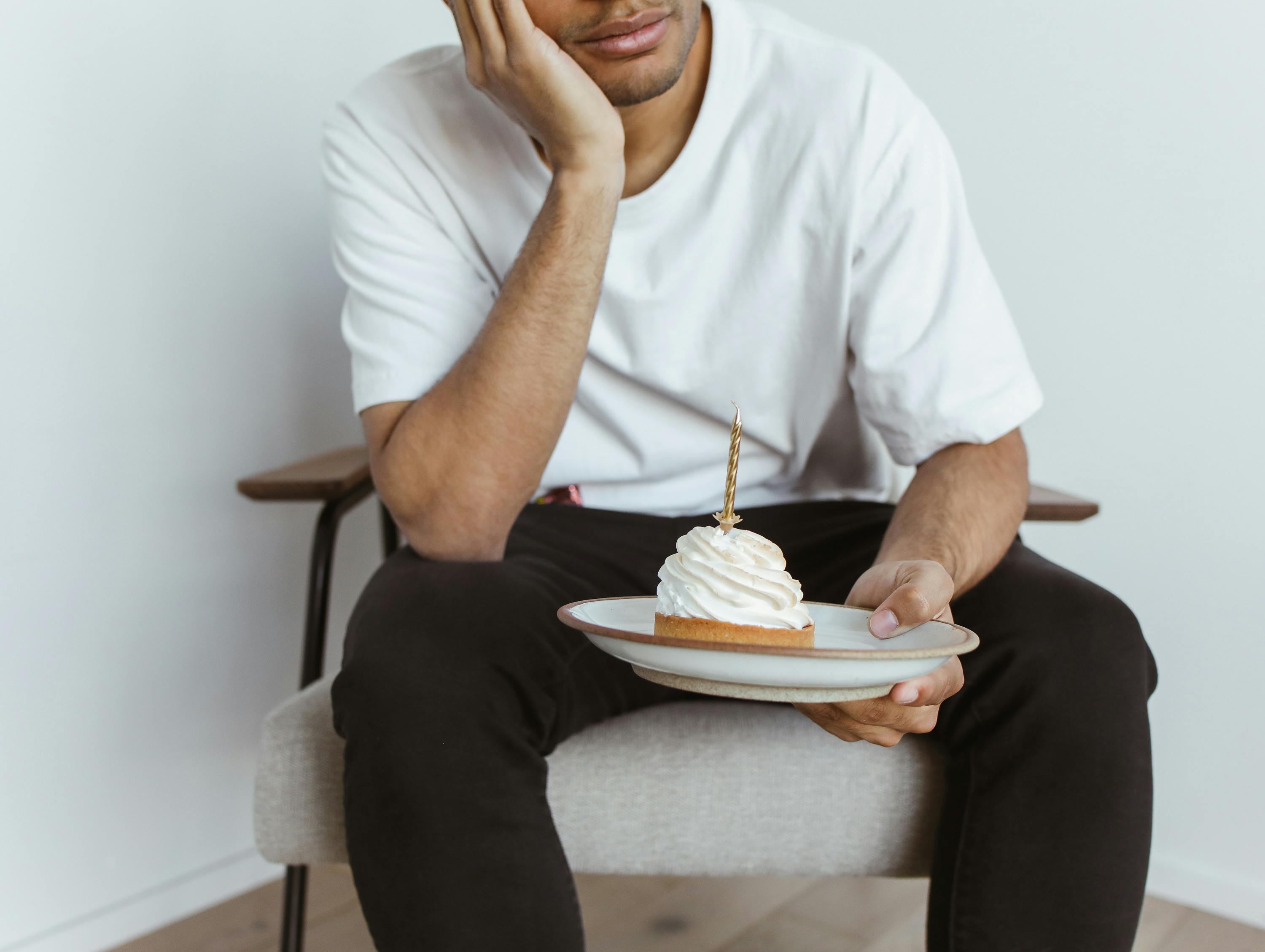 A Man Holding a Cake on a Plate · Free Stock Photo