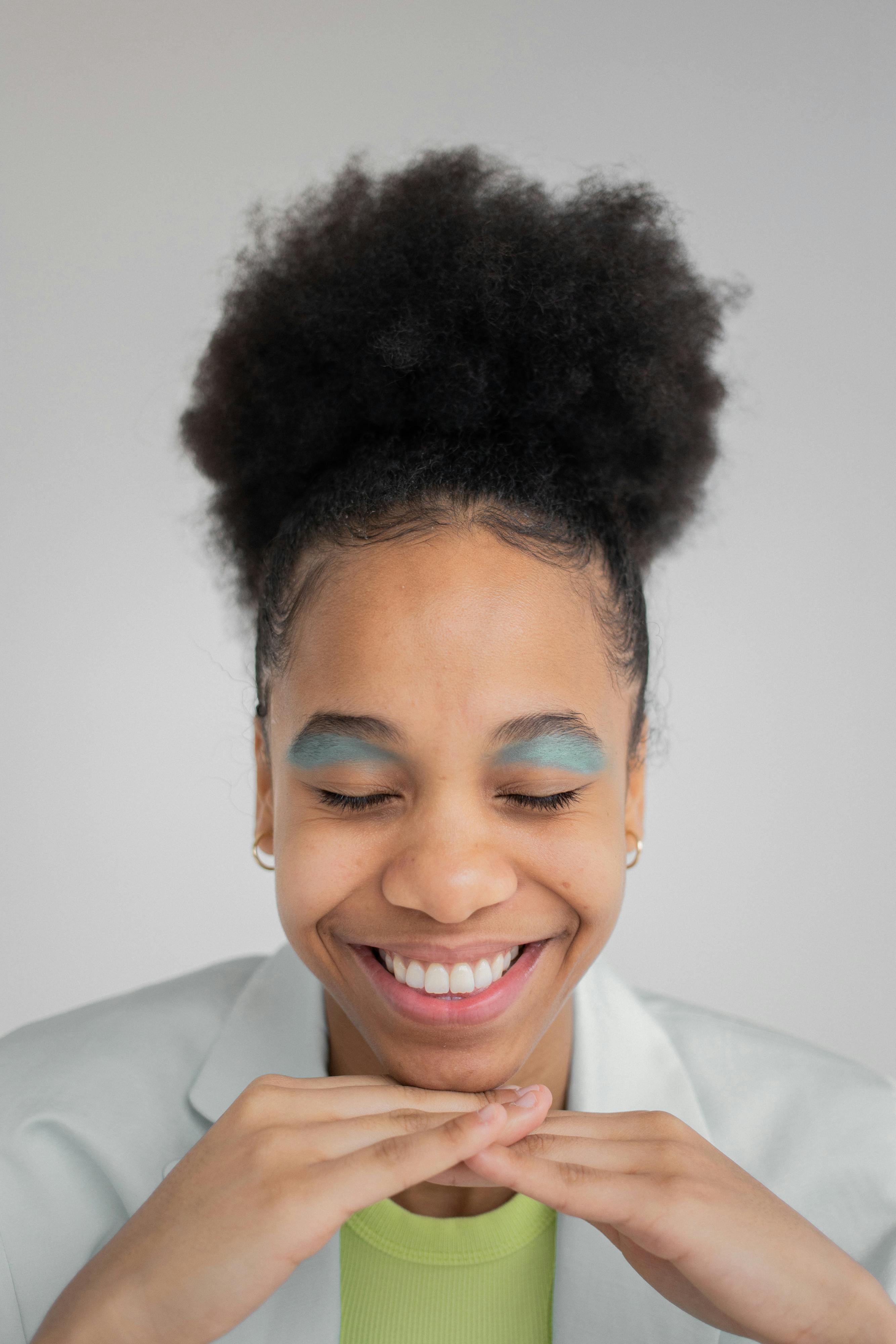 Content young black female model smiling in studio · Free Stock Photo