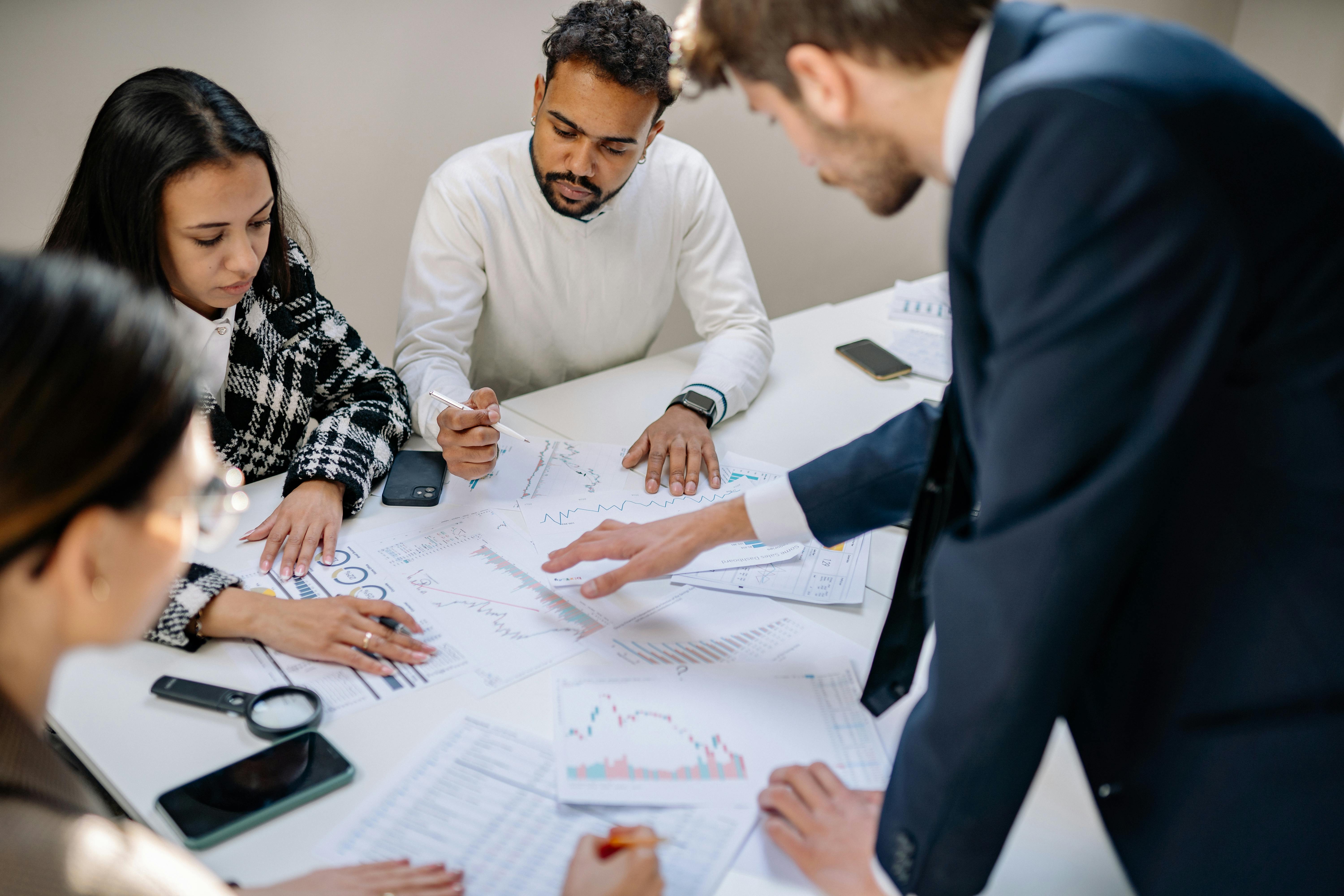 A Low Angle Shot of People Doing Teamwork · Free Stock Photo