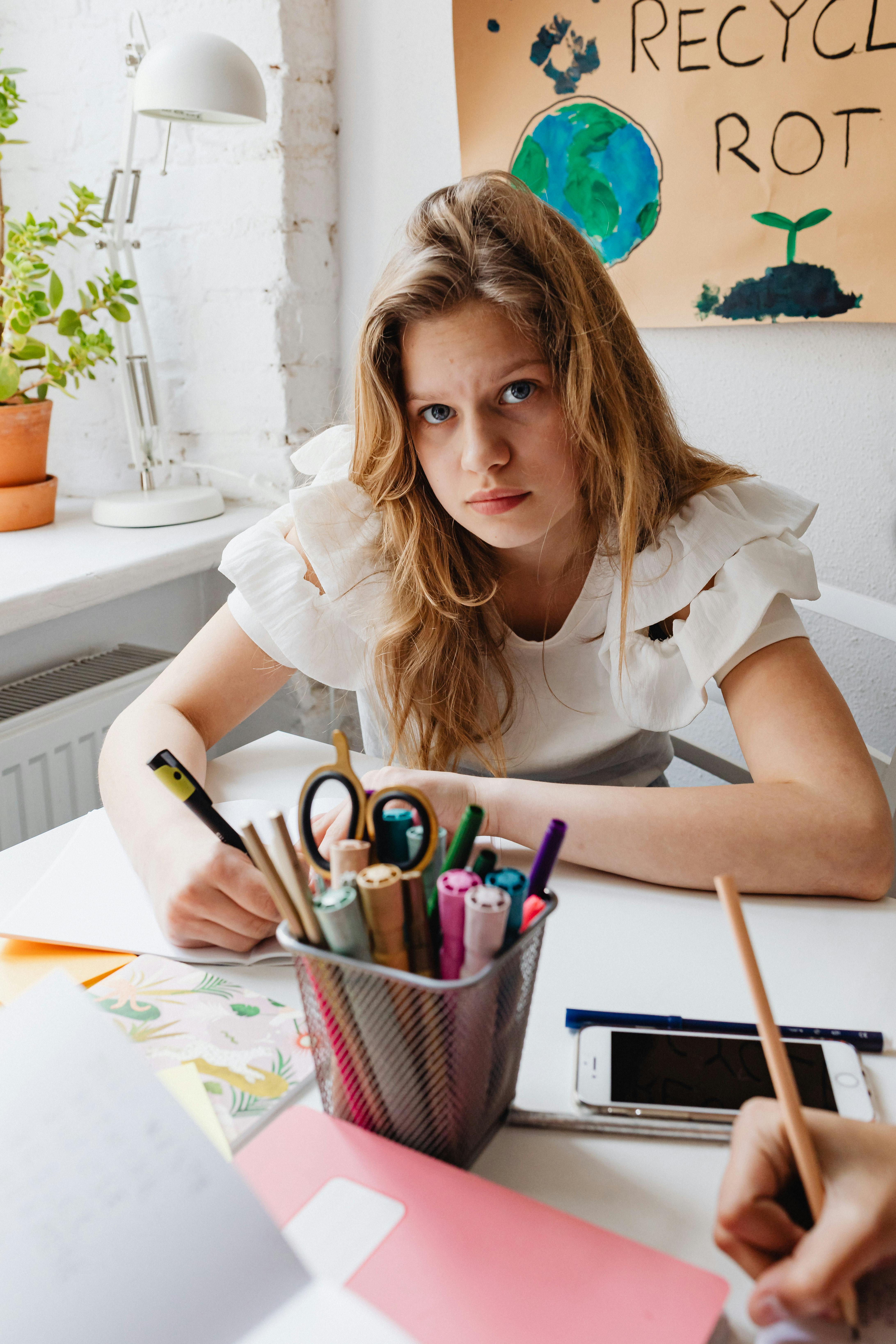 A Girl Student Writing on the Notebook · Free Stock Photo