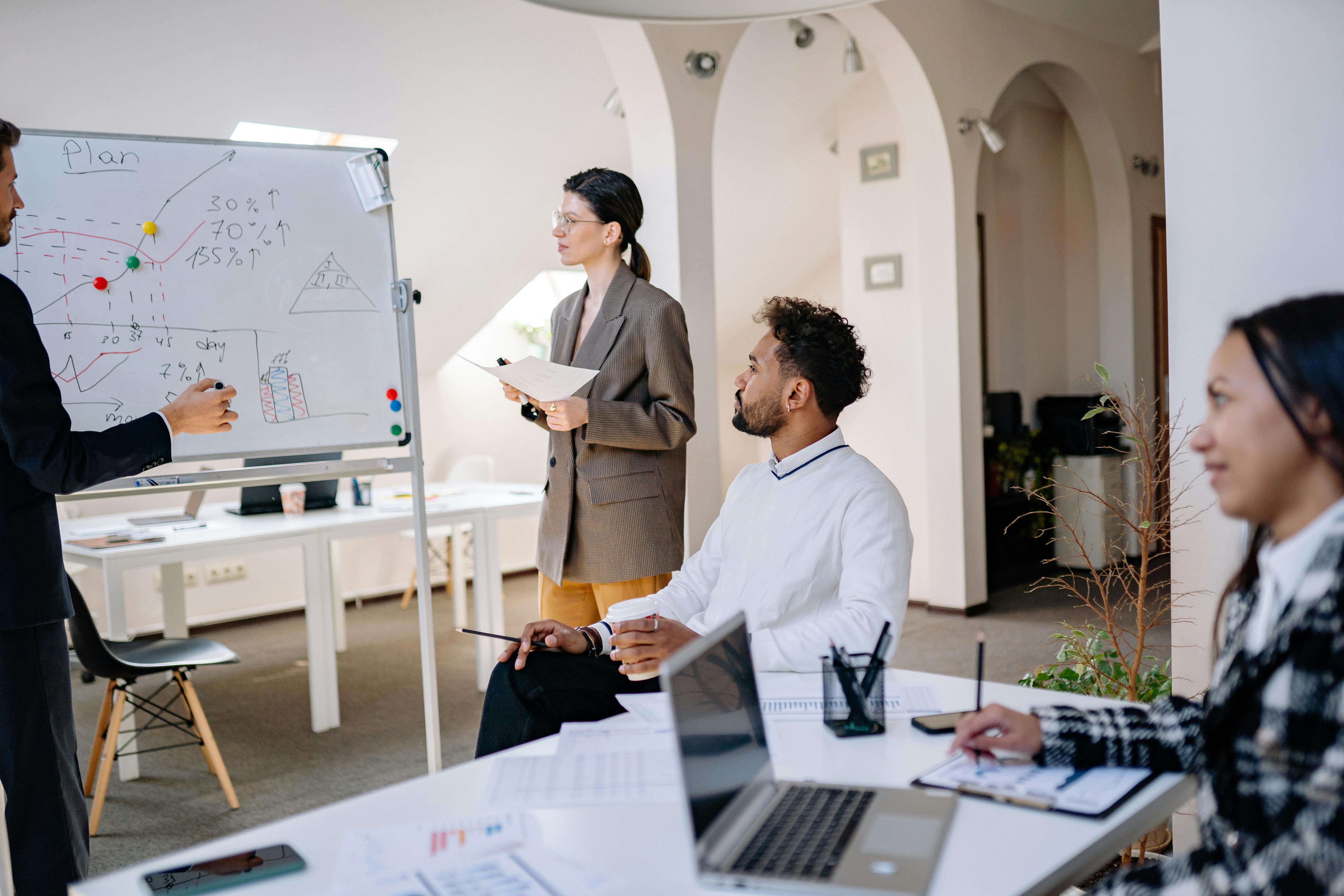 Man and Woman Presenting in Front of the Room · Free Stock Photo