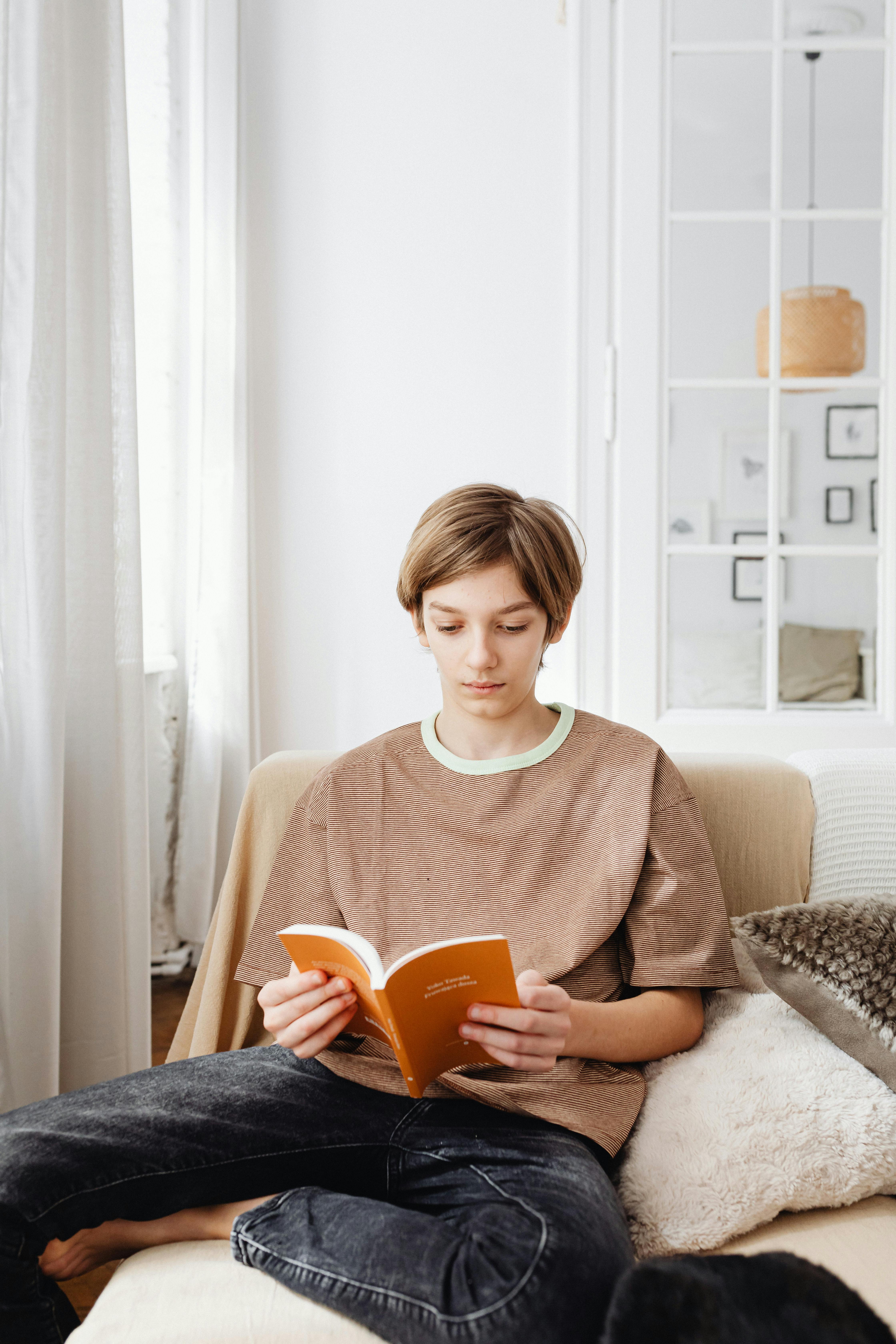 A Boy Reading a Book · Free Stock Photo