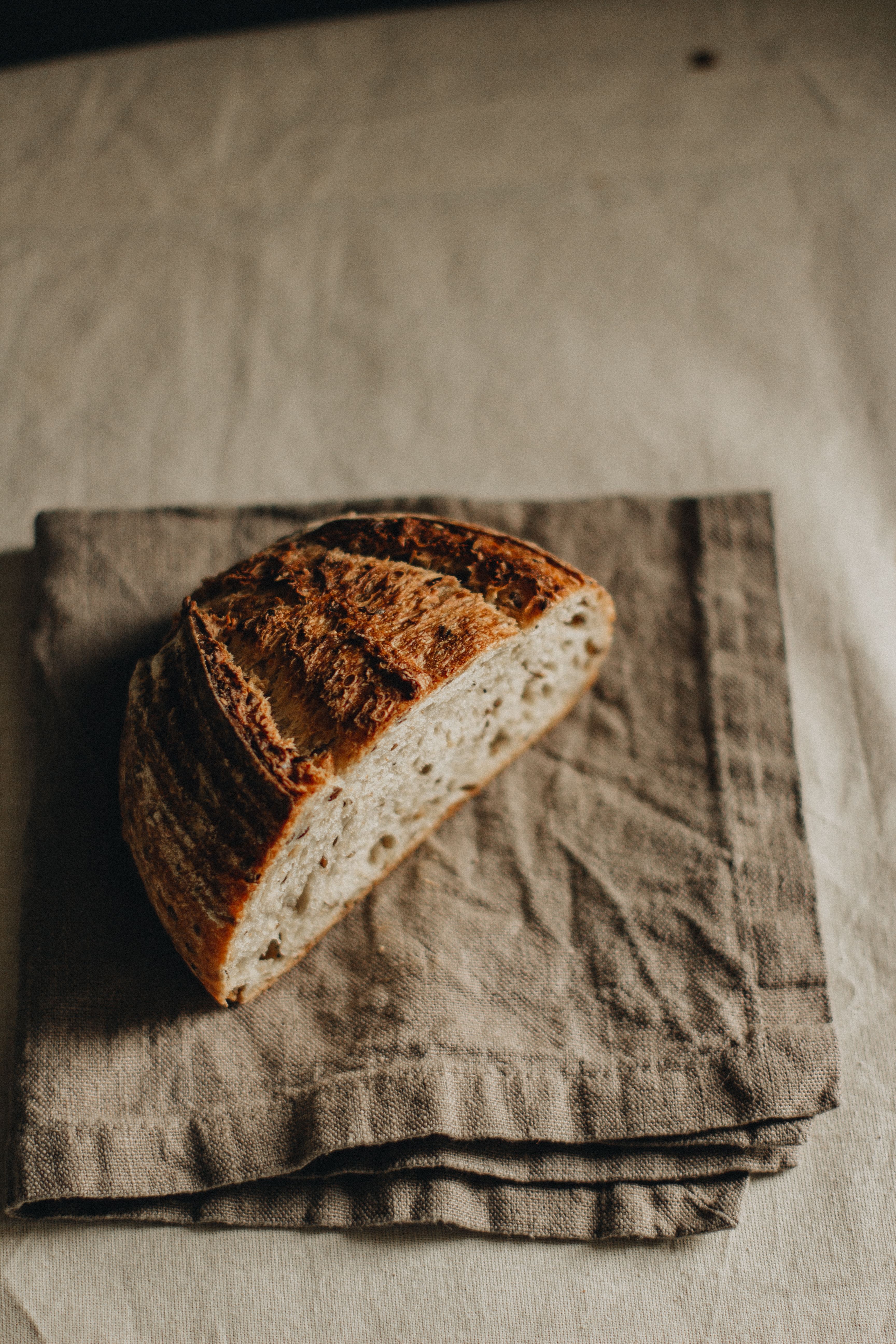 Crop unrecognizable person showing fresh cut bread · Free Stock Photo