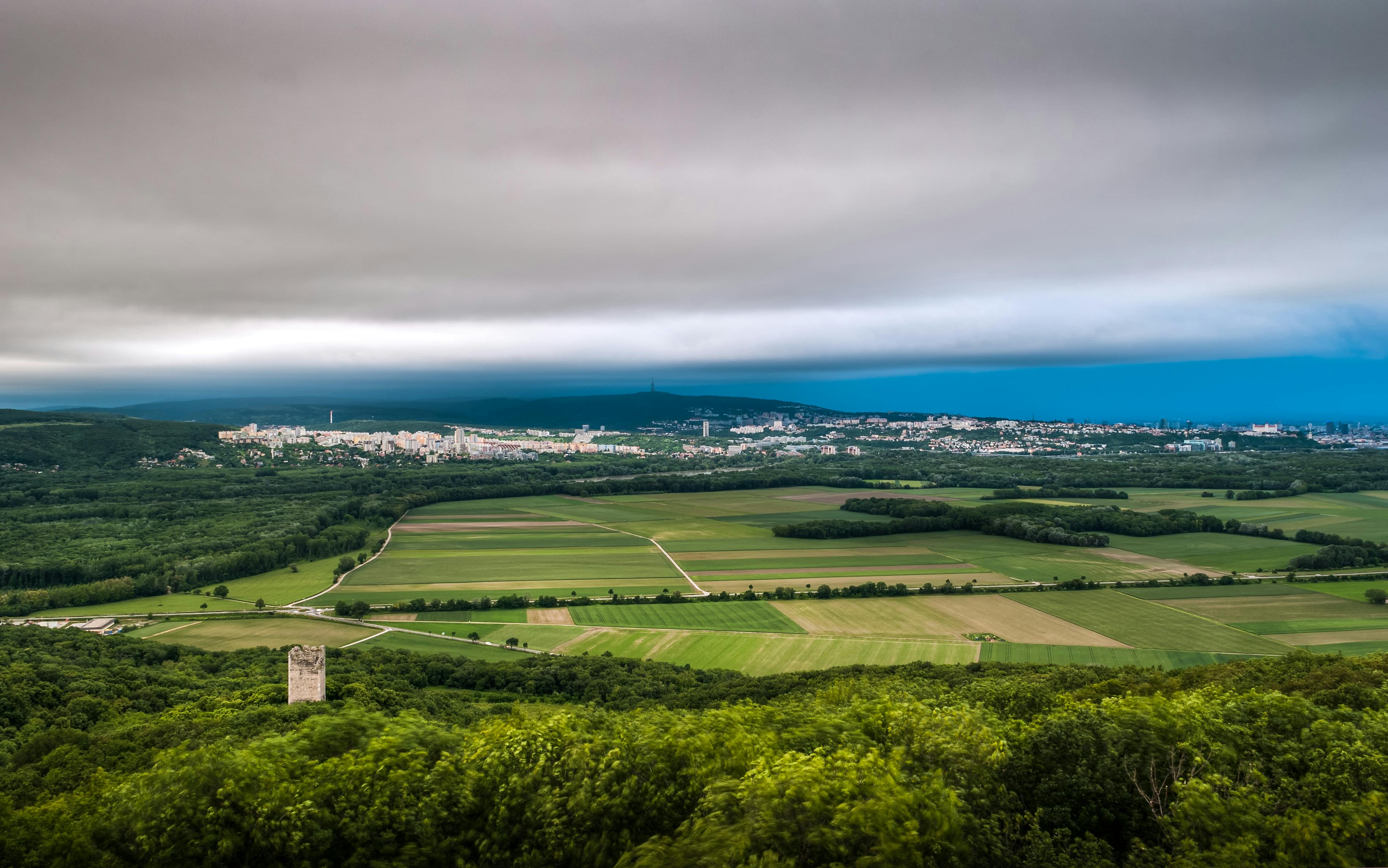 Aerial View of a Town between a Few Hills on a Flat Land · Free Stock Photo