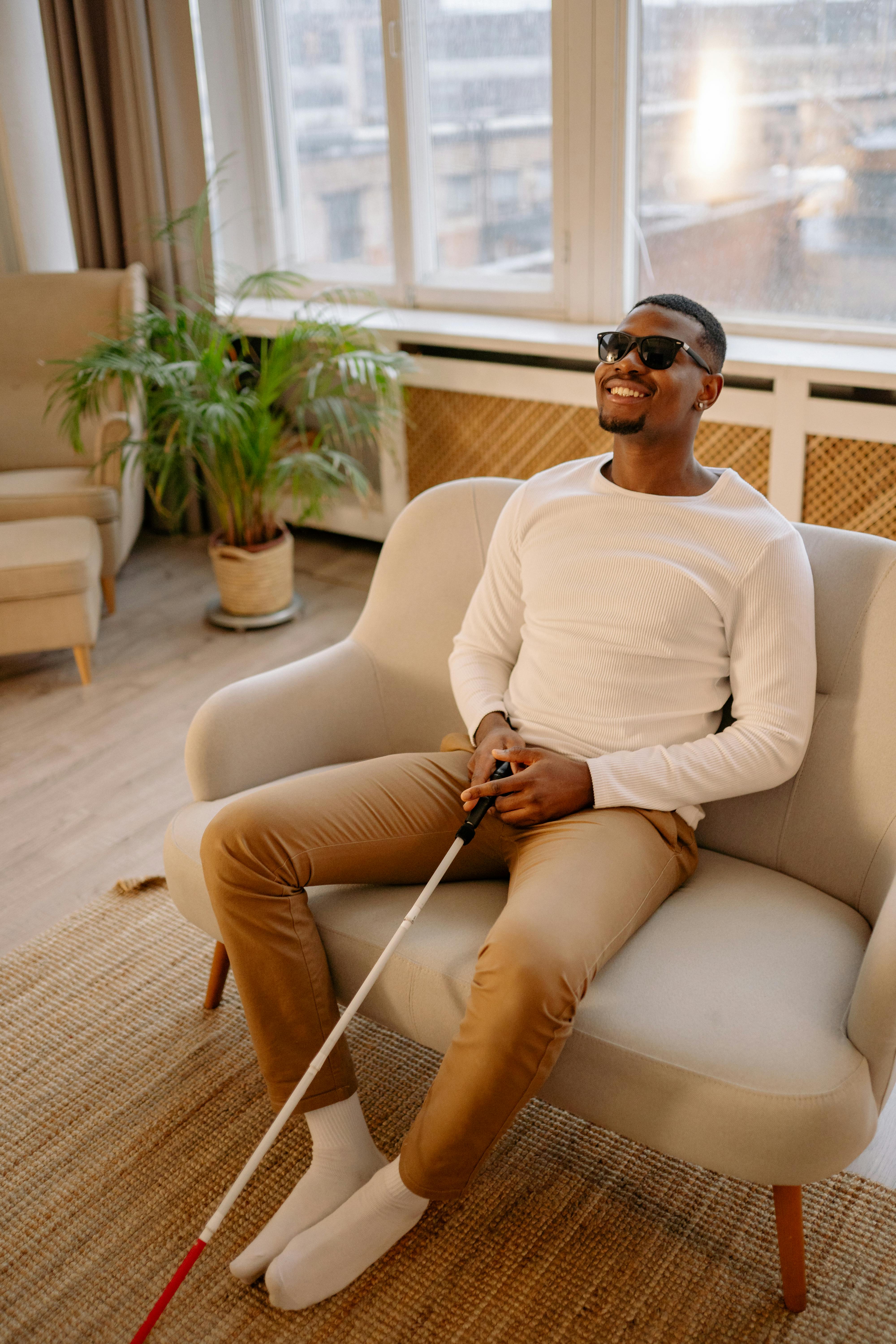 Smiling Blind Man sitting on Sofa · Free Stock Photo