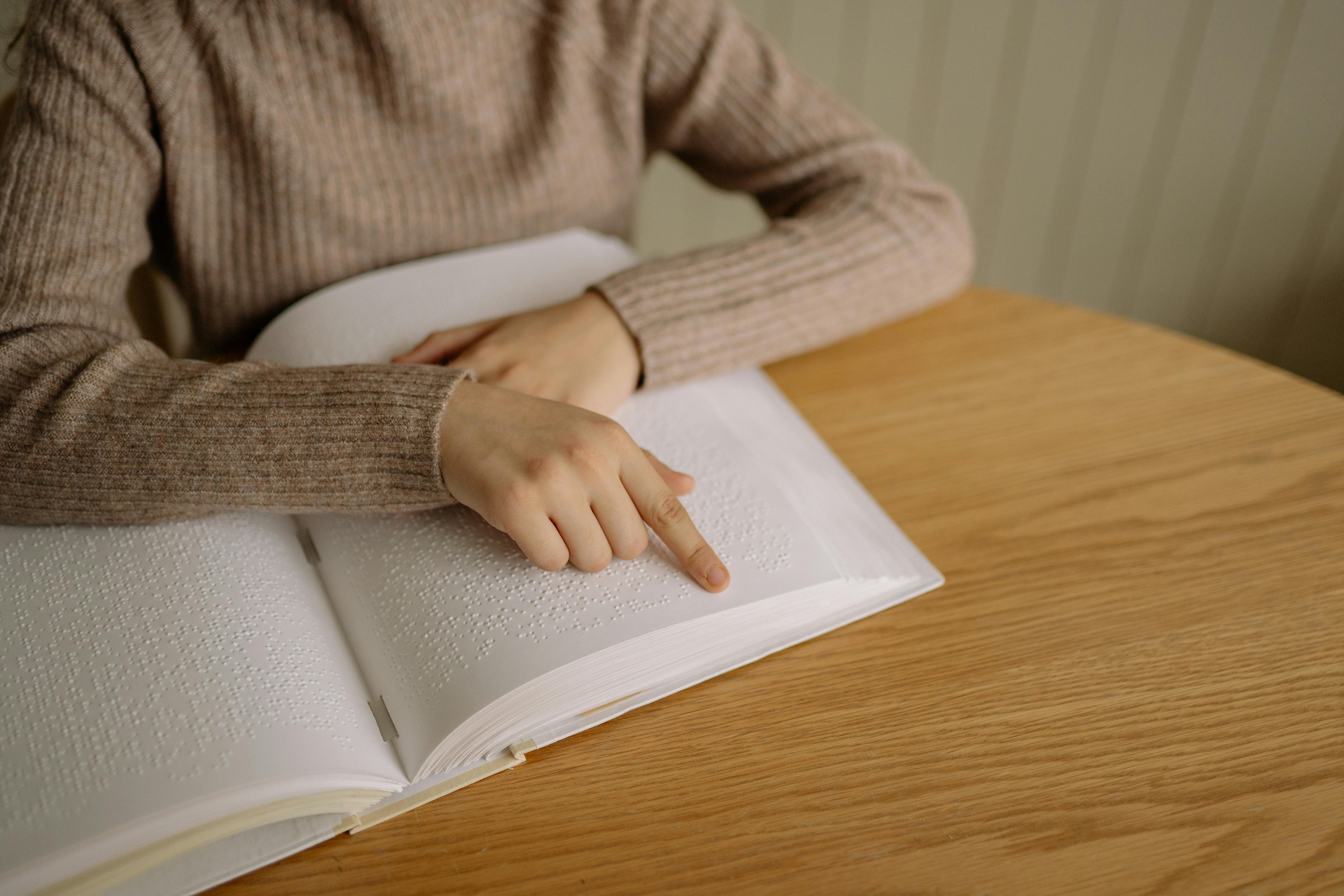 Close up of a Person Reading a Braille Book · Free Stock Photo