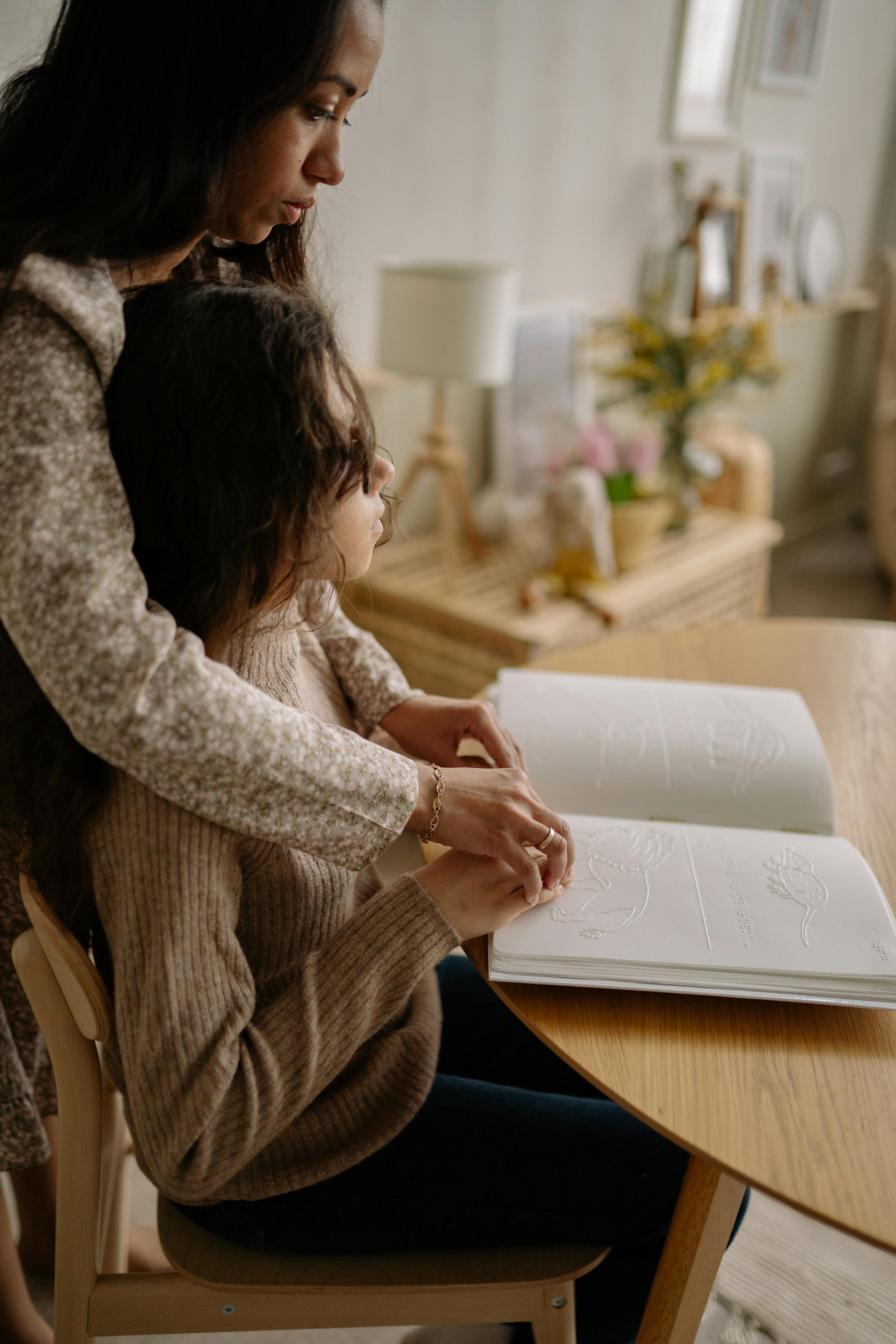 A Blind Woman Reading a Braille Book · Free Stock Photo
