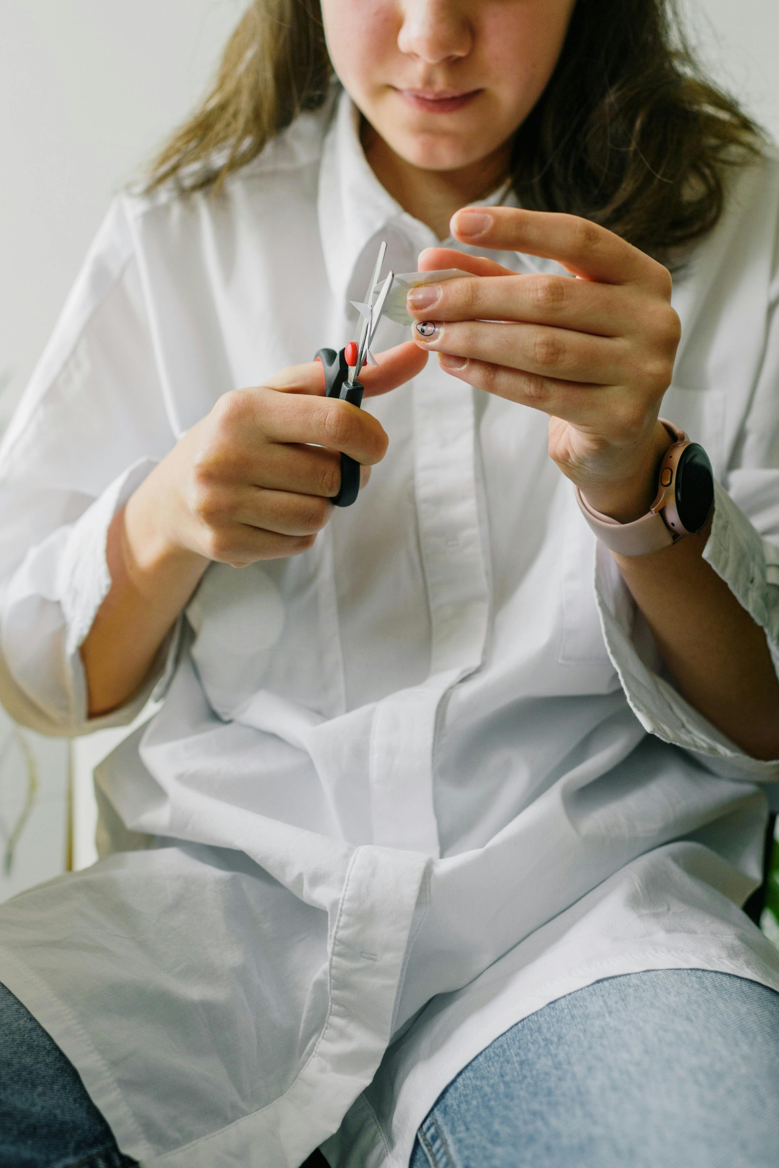 Person Cutting a Rosemary Herb Using Black Scissors · Free Stock Photo
