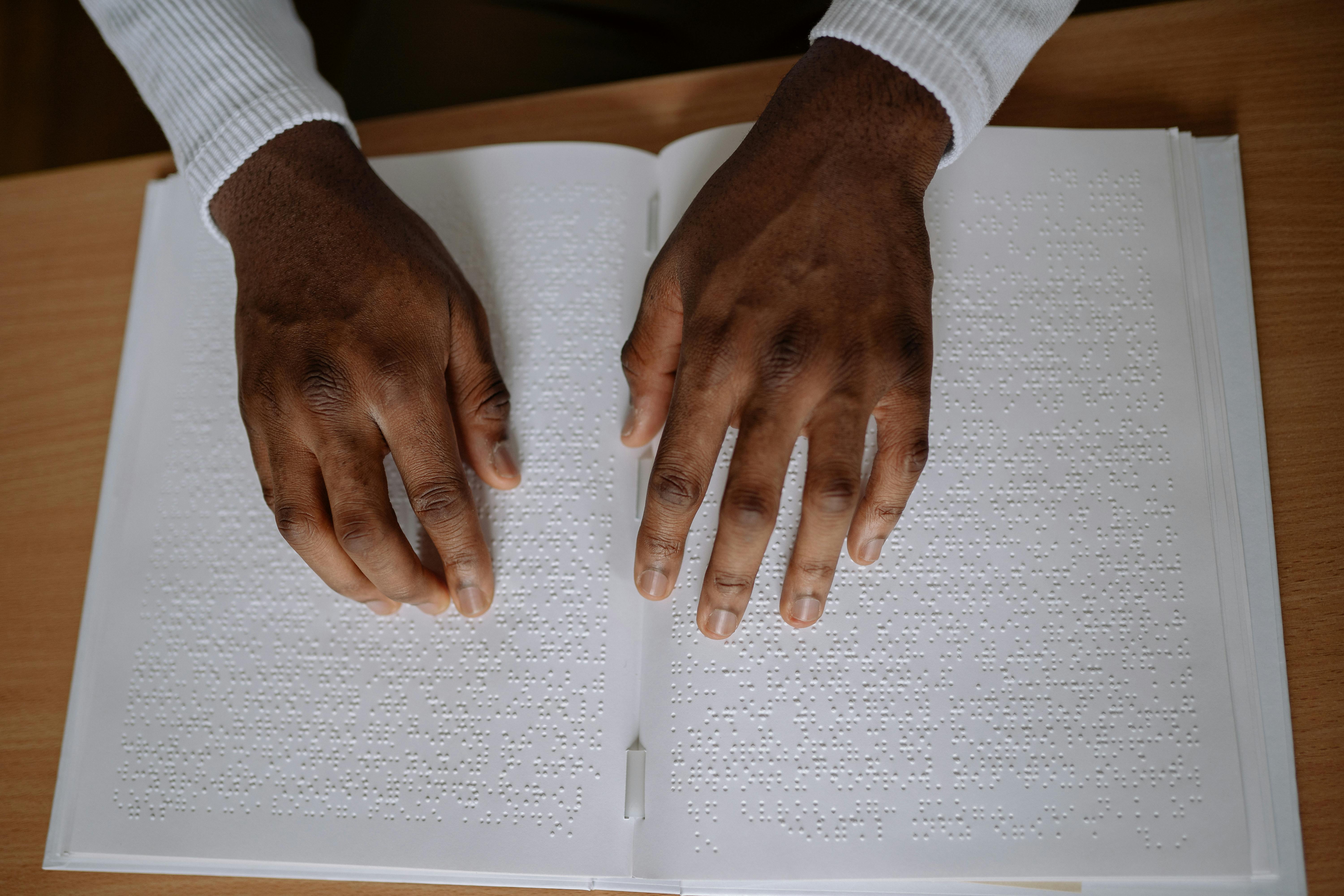 Hand Touching a Braille Book · Free Stock Photo