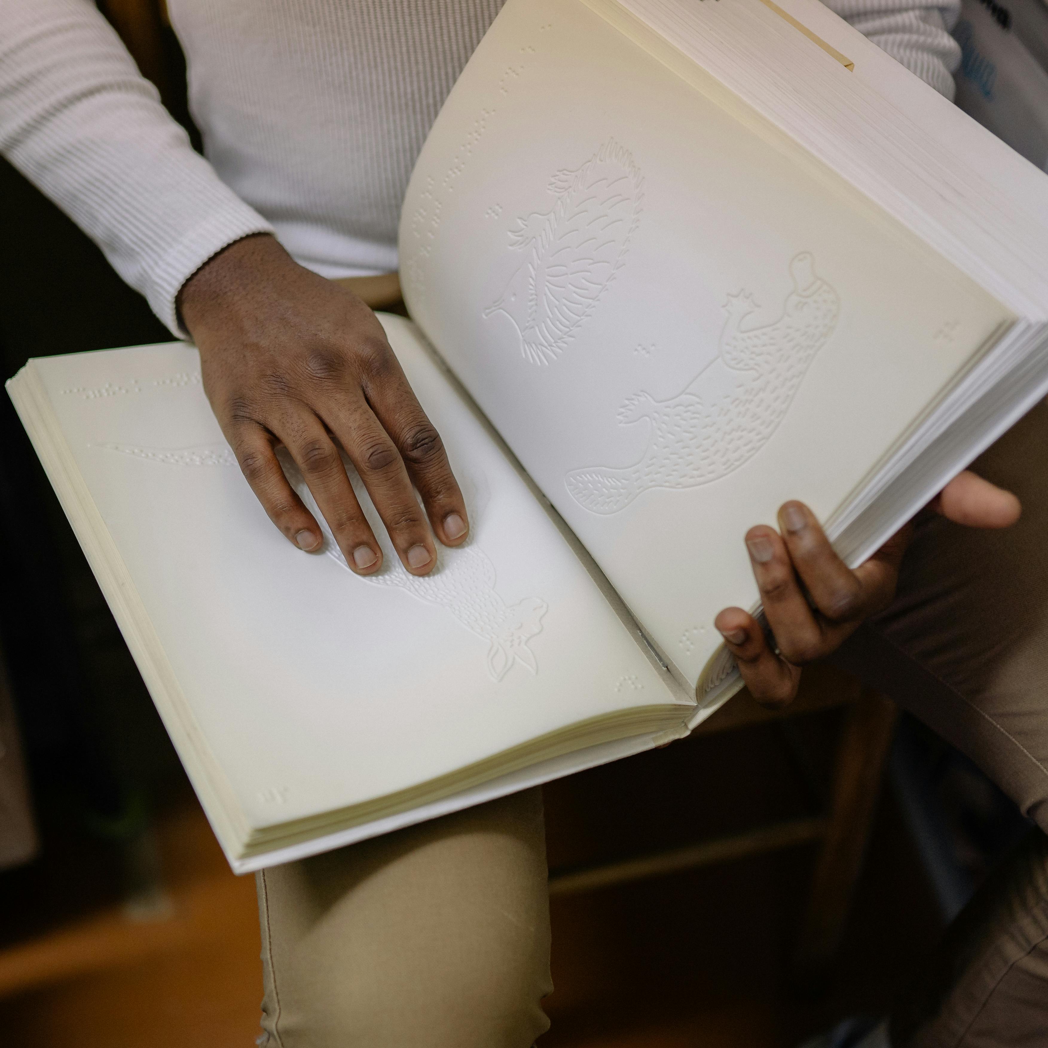 A Person Reading a Braille Book · Free Stock Photo