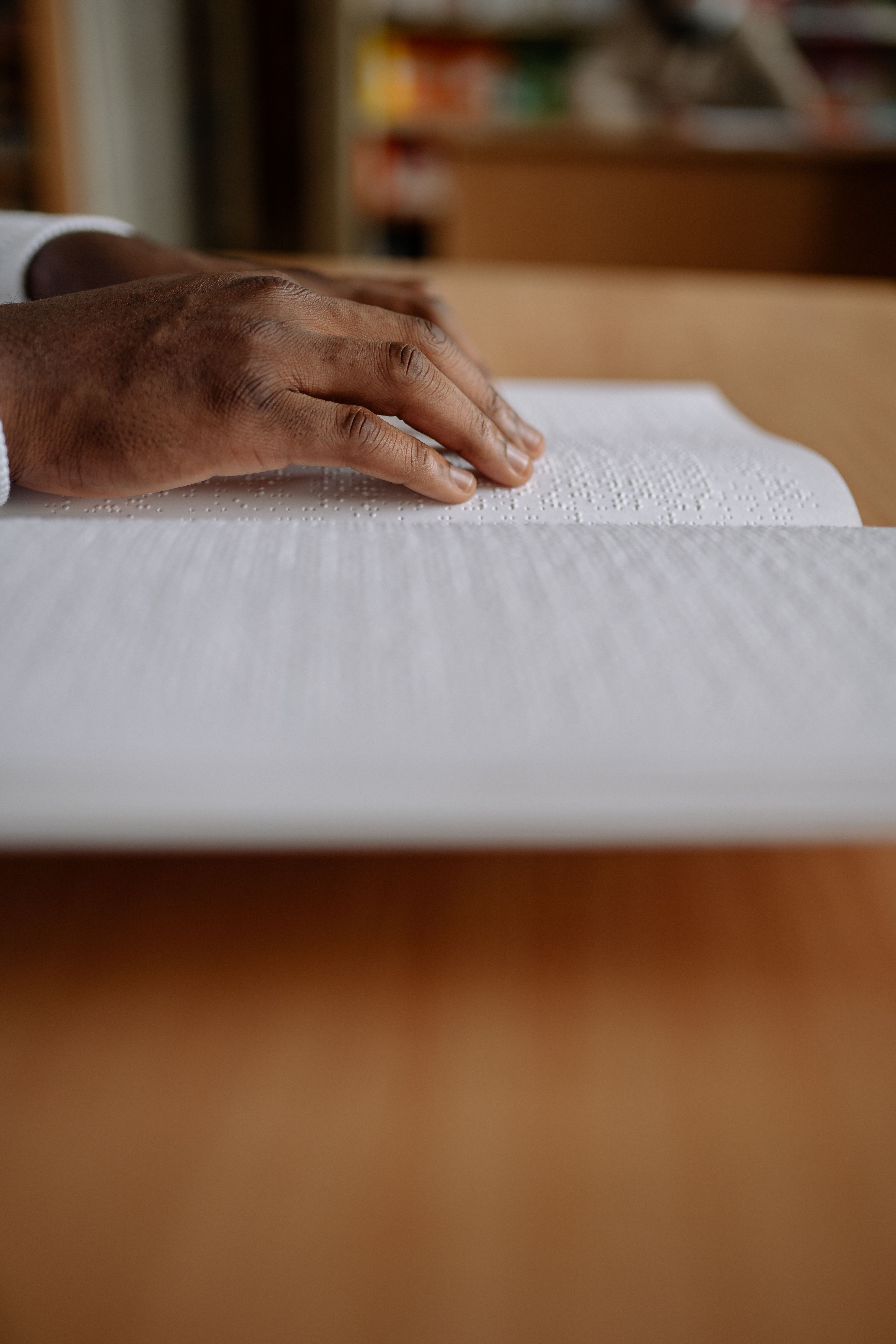 A Person Touching the Page of a White Book · Free Stock Photo