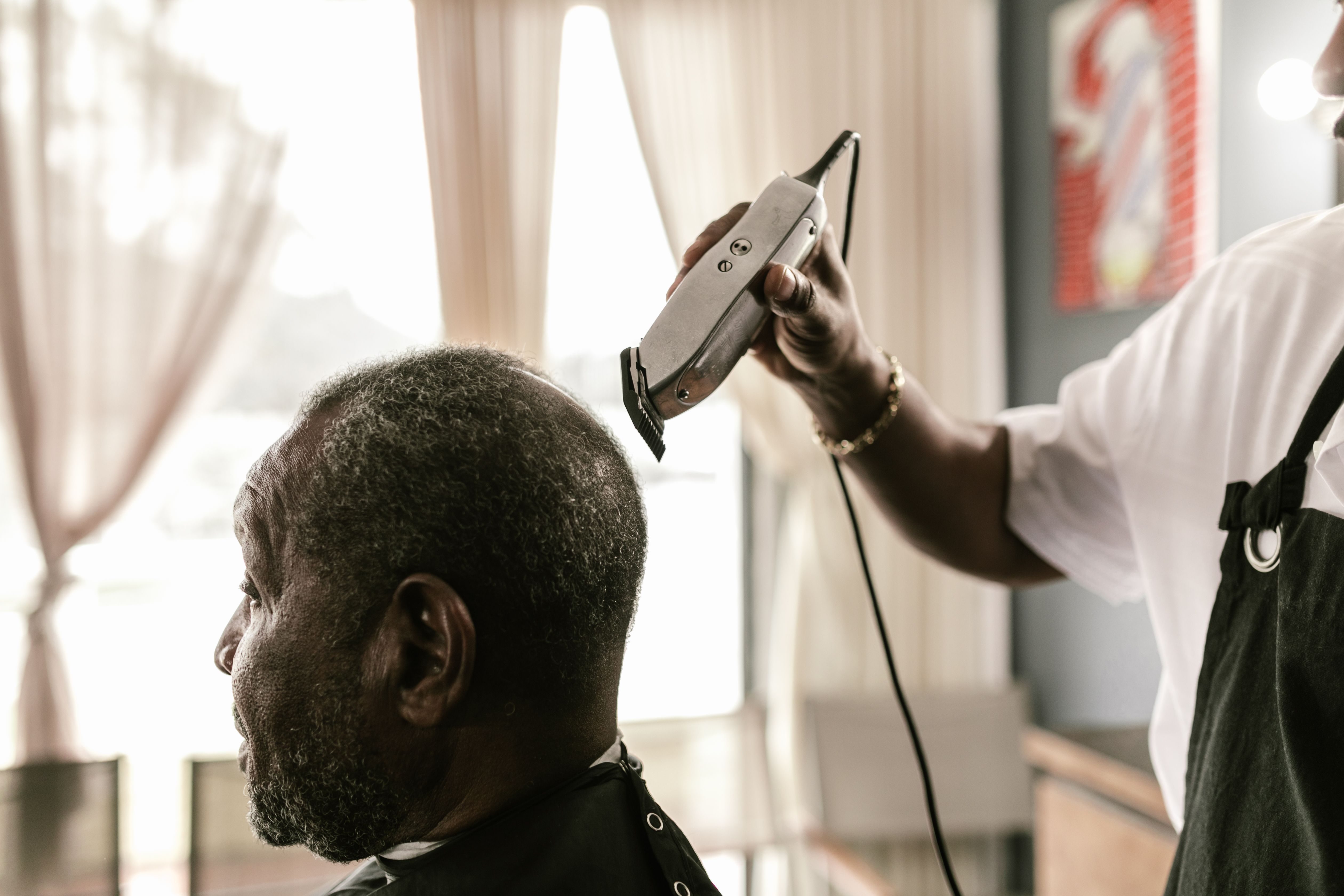 Person in White Shirt Holding a Silver Razor · Free Stock Photo