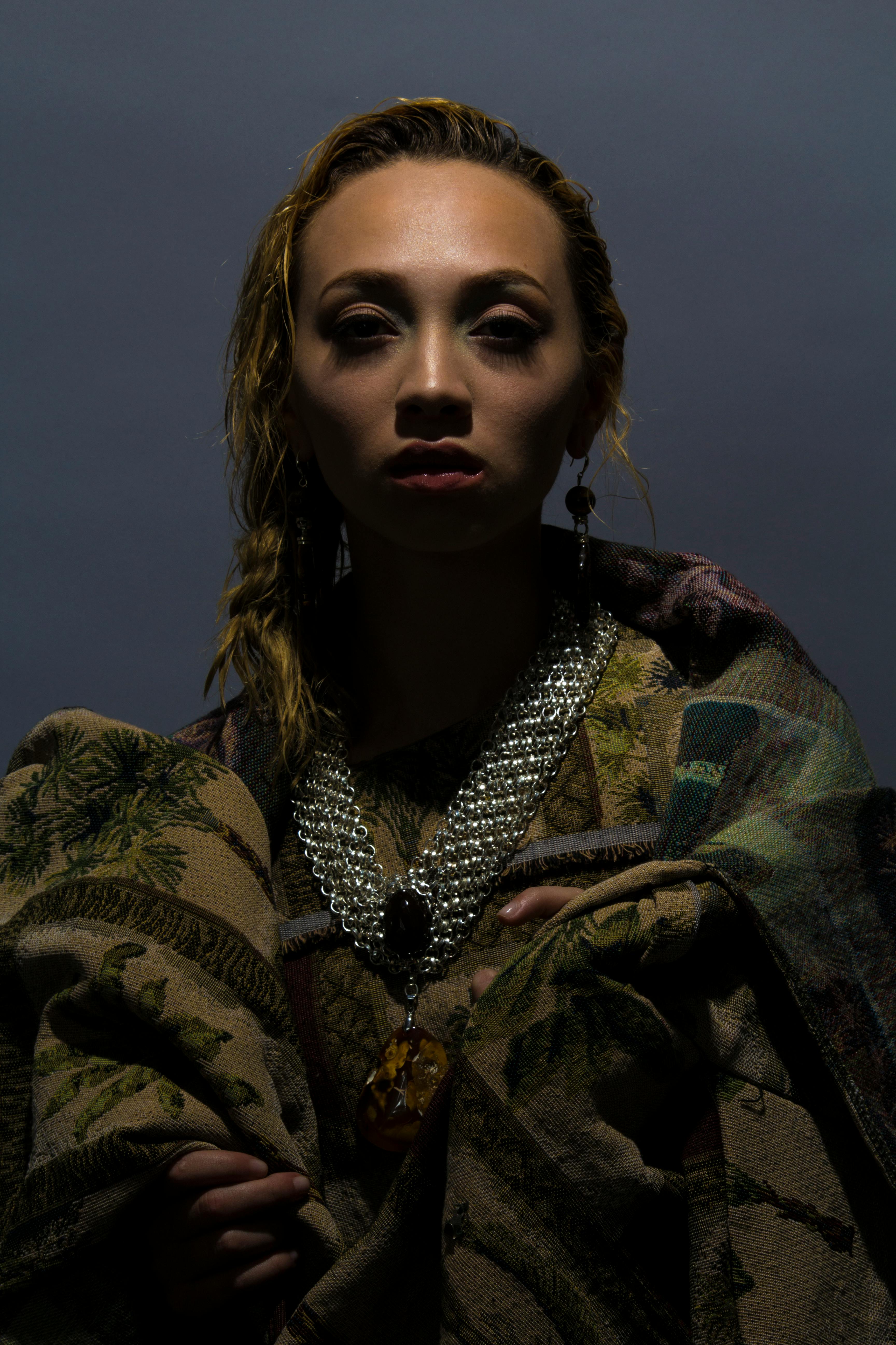 Woman with Makeup Posing under a Concrete Construction · Free Stock Photo