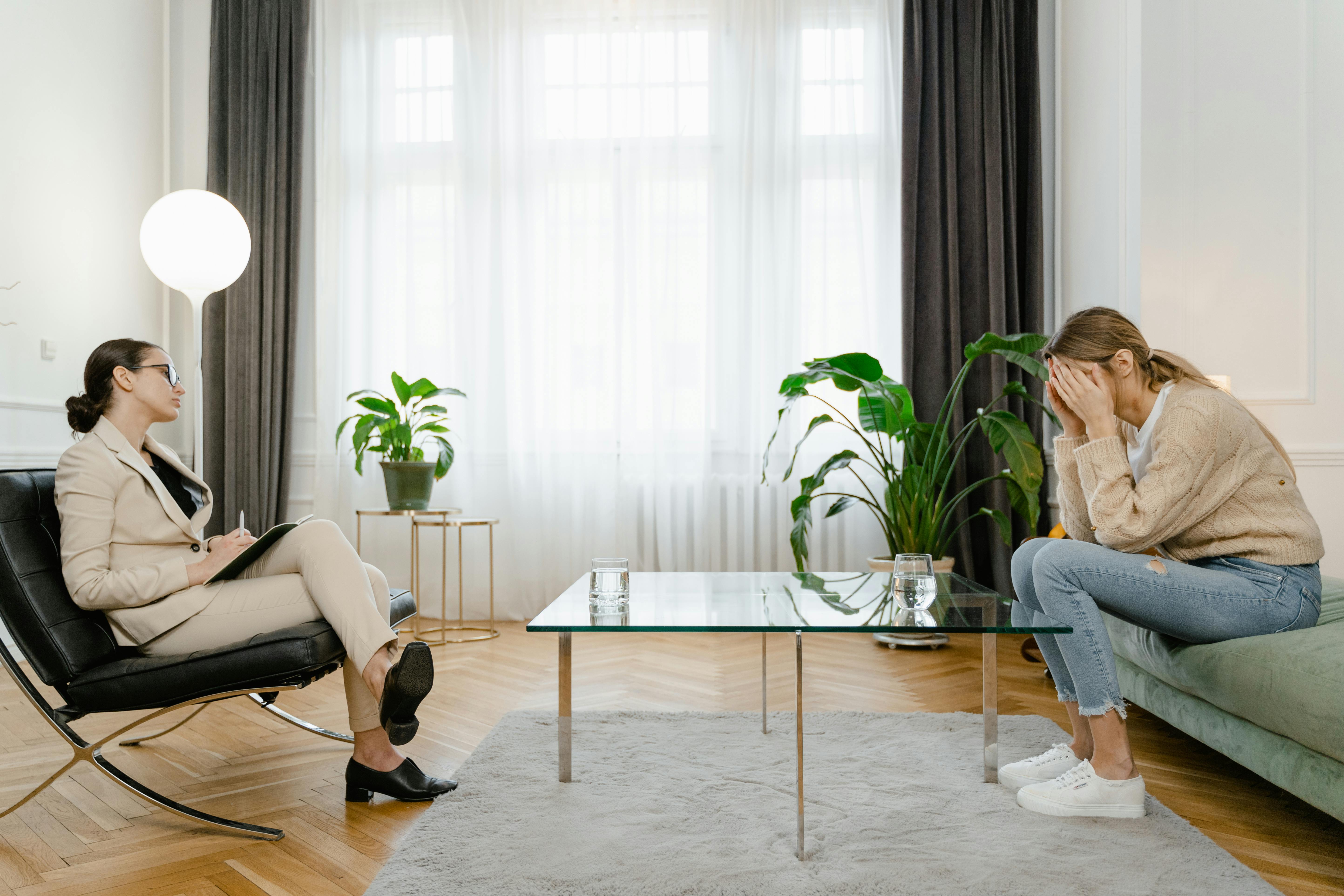 Two Women Talking while Sitting on the Sofa · Free Stock Photo
