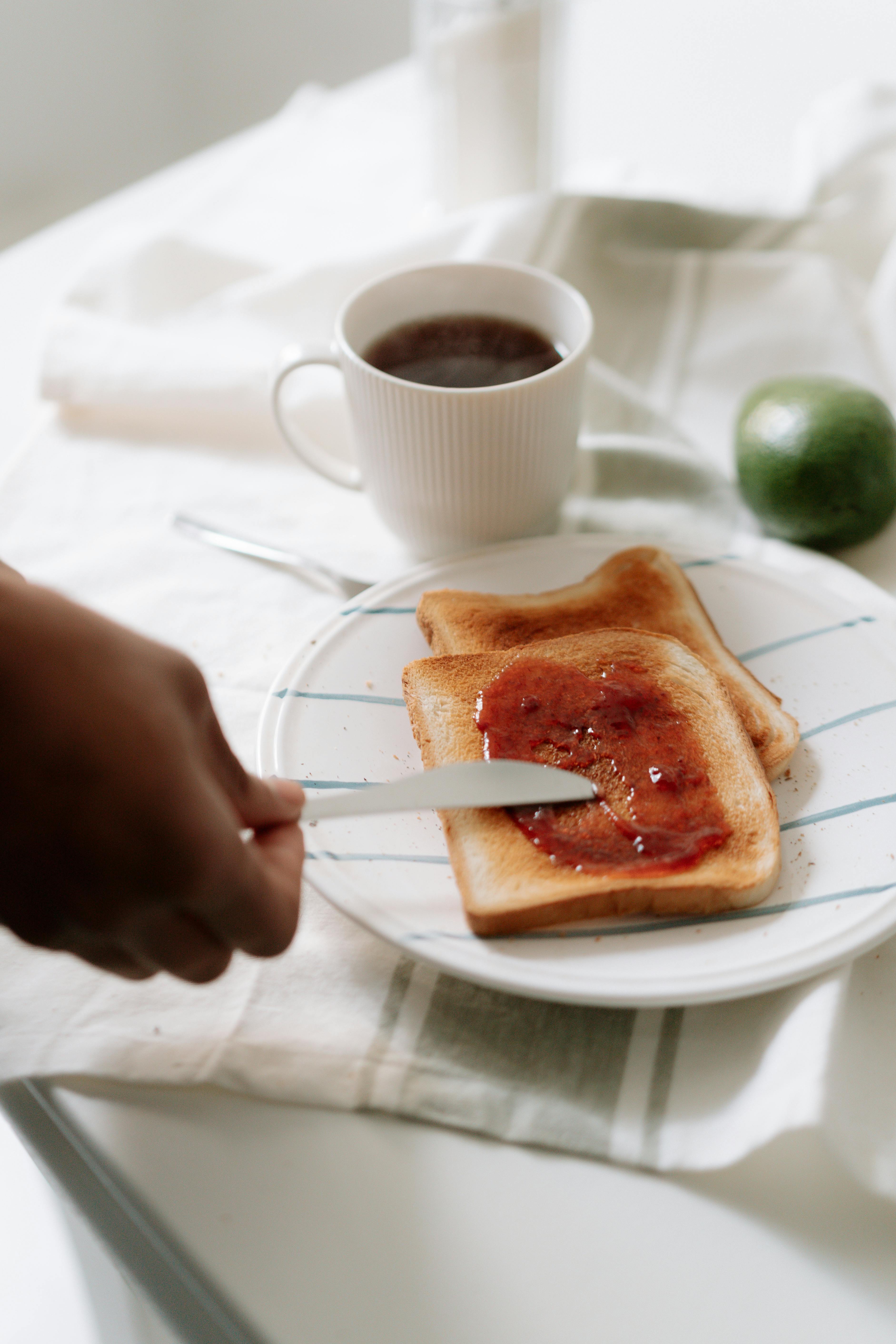 A Person Spreading Jam on Toast · Free Stock Photo
