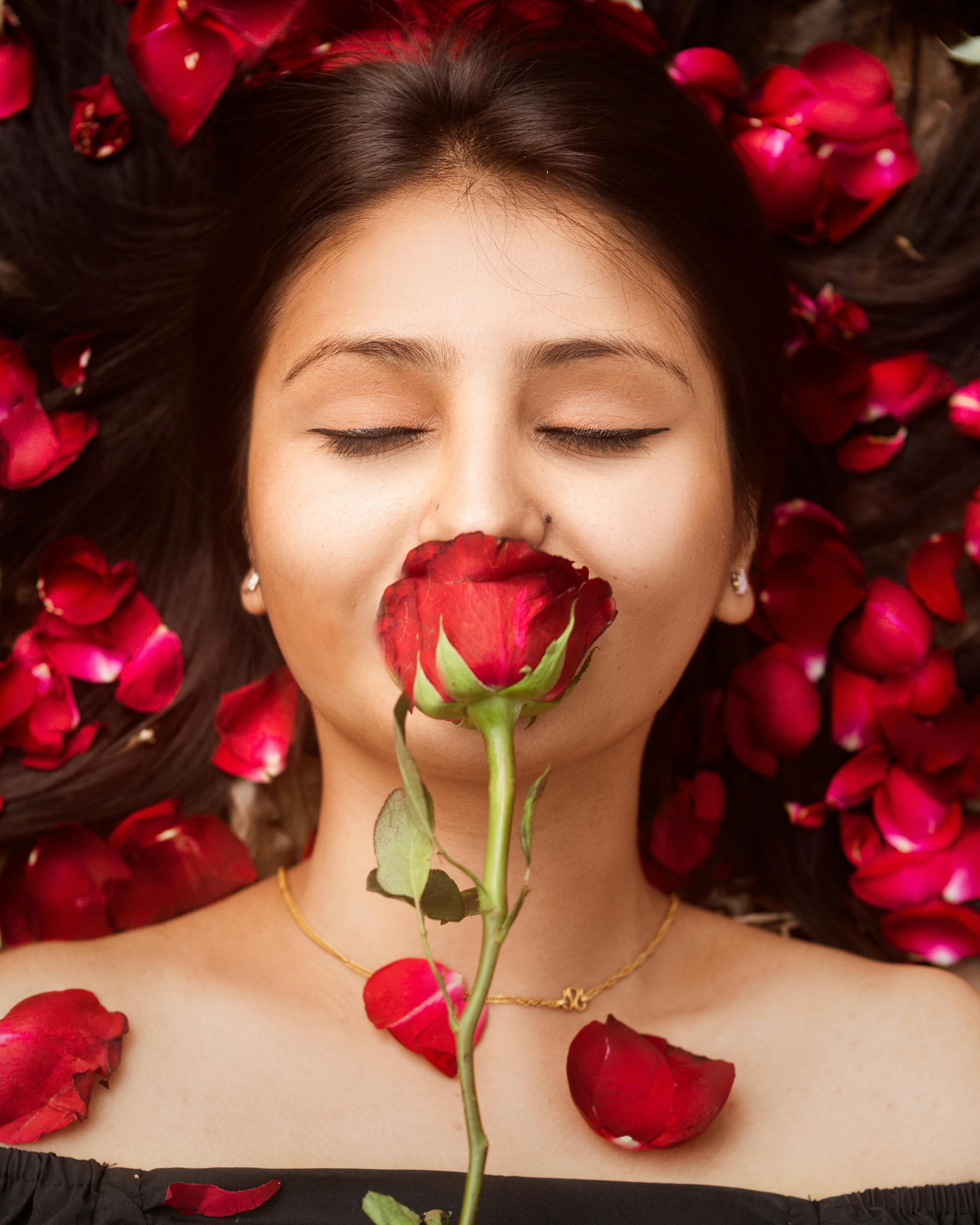 Woman with a Rosebud on Her Lips · Free Stock Photo