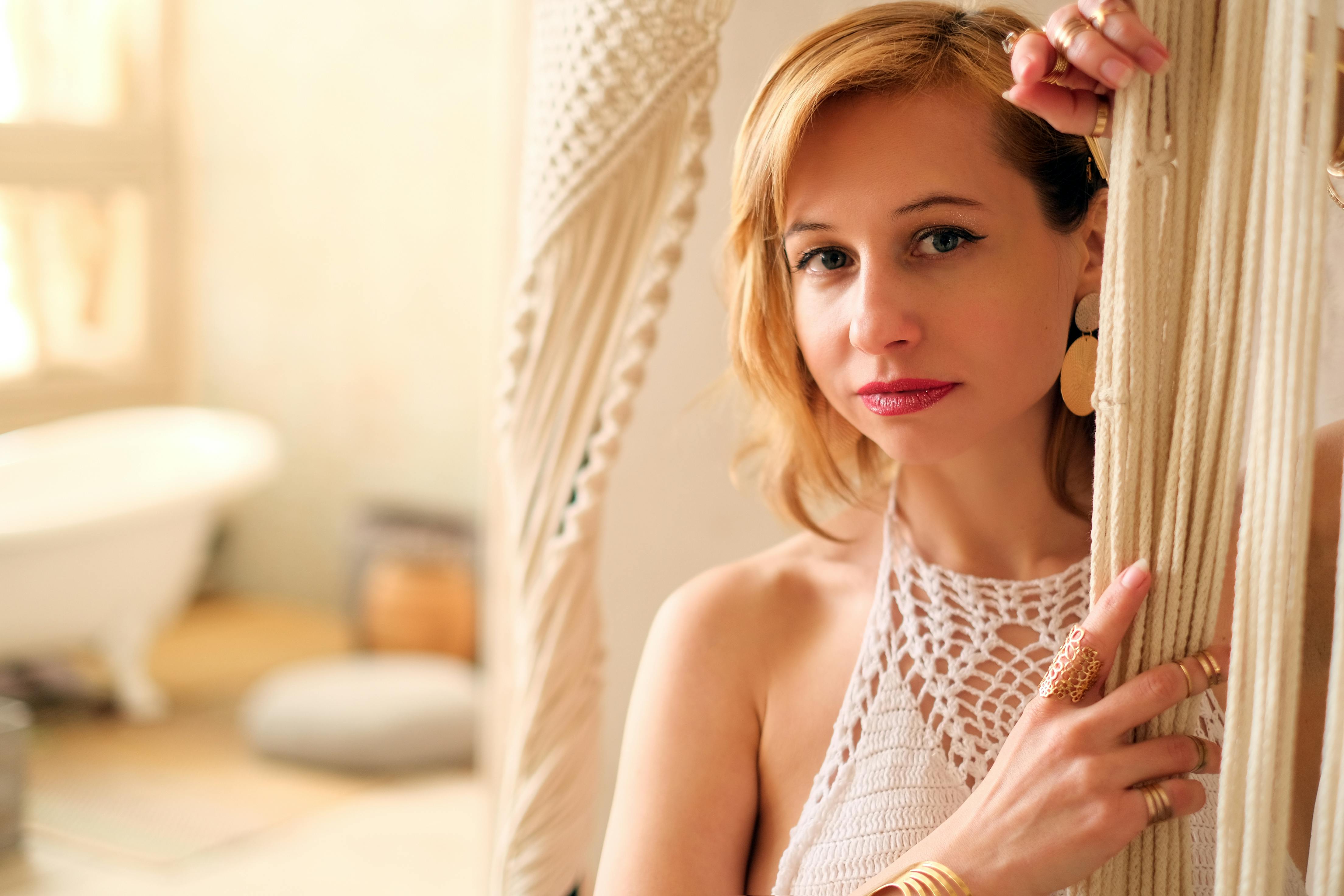 Young ethnic woman in black bra with champagne in hand · Free Stock Photo