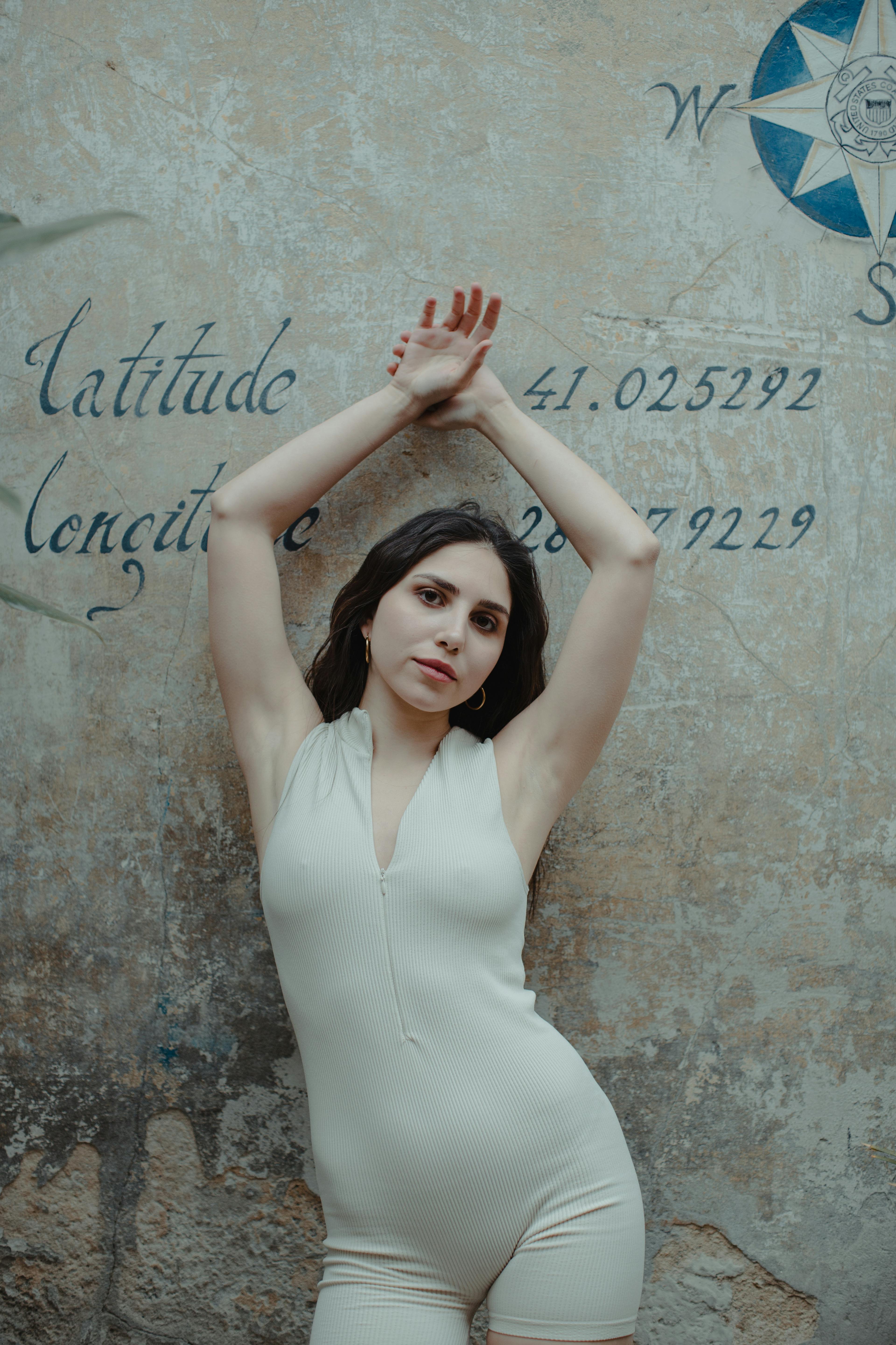 Woman Posing with Arms Raised · Free Stock Photo
