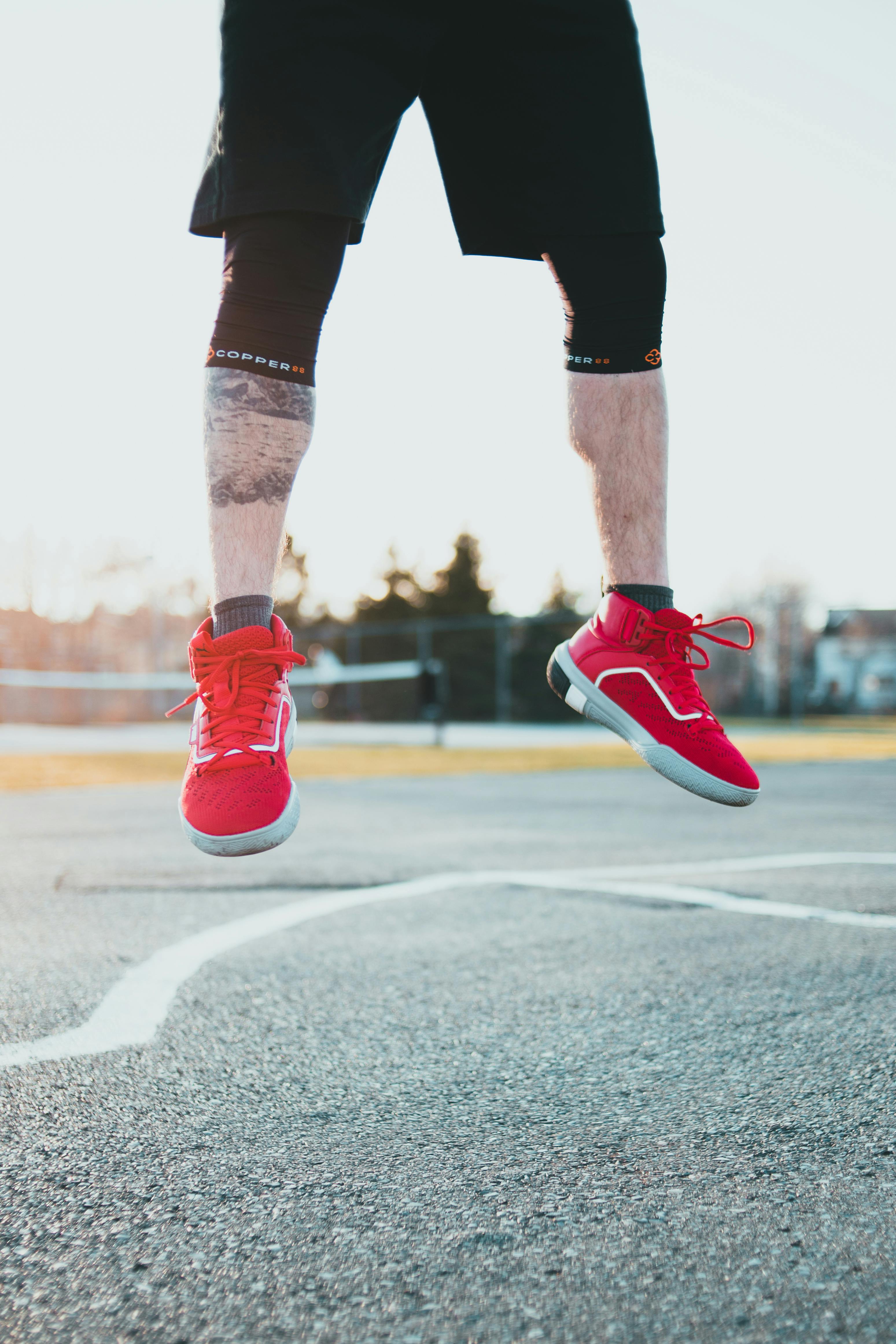 Unrecognizable sportsman jumping on playground · Free Stock Photo