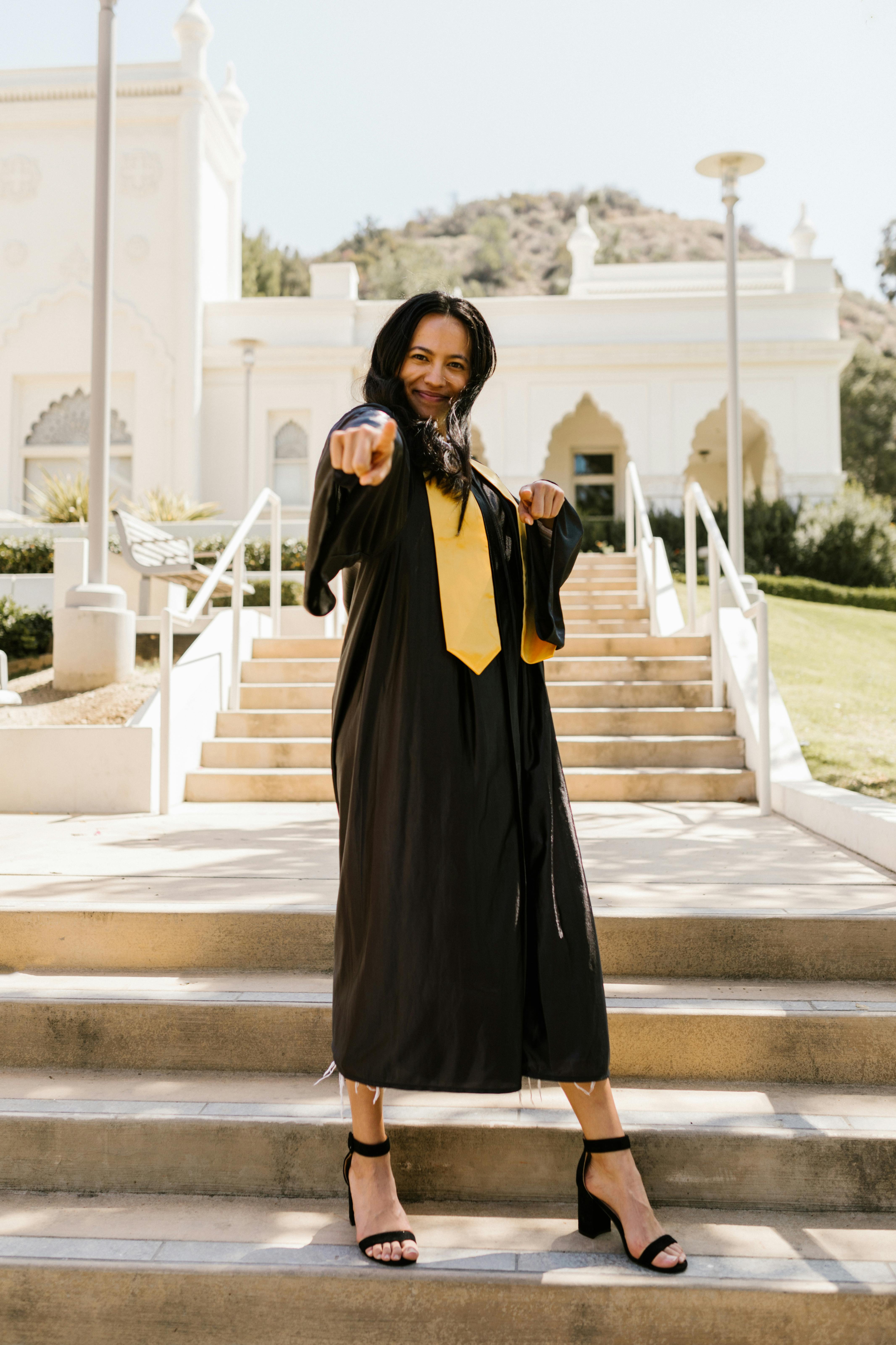 Woman Wearing Graduation Gown Posing · Free Stock Photo