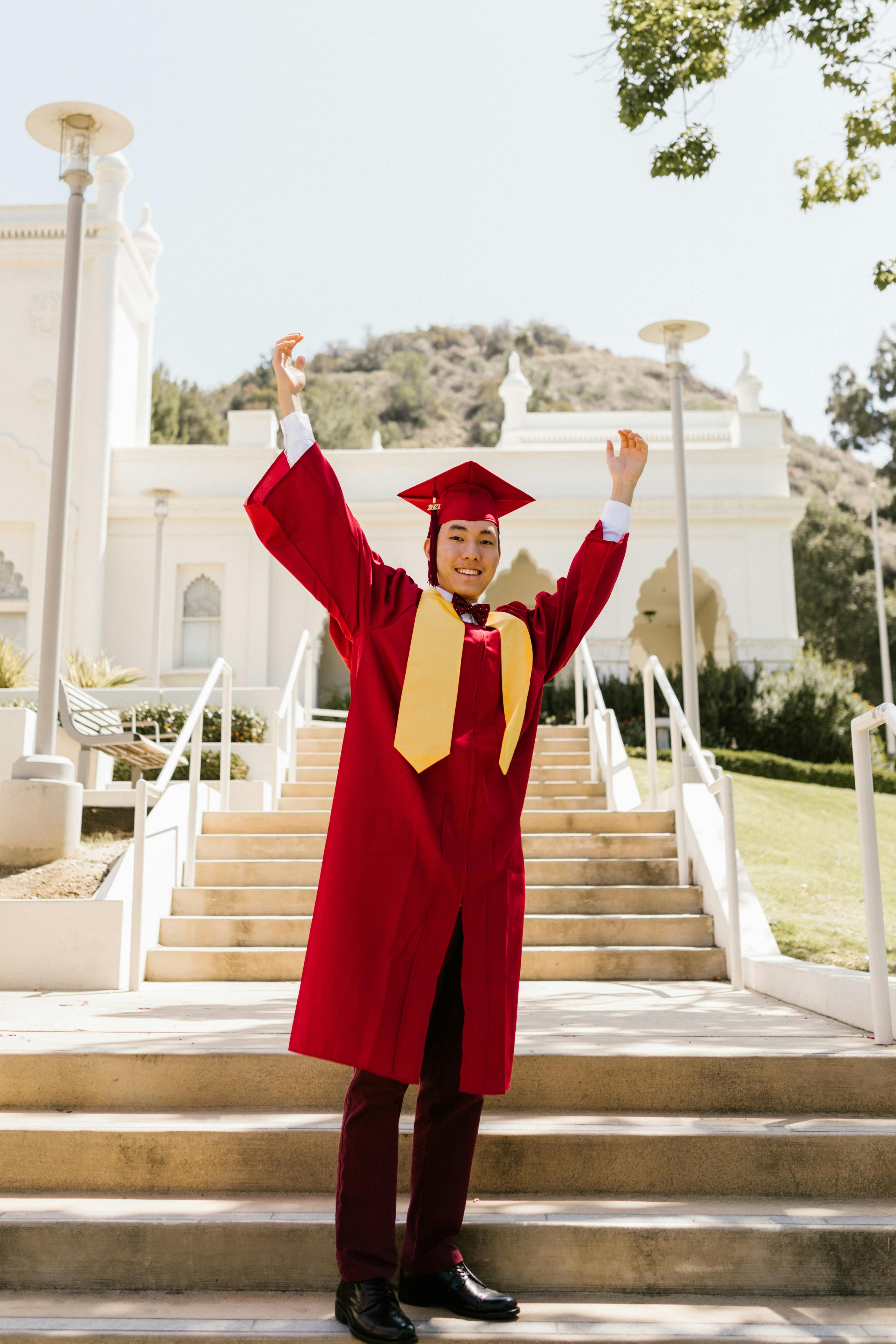 Man Wearing Graduation Gown Posing · Free Stock Photo