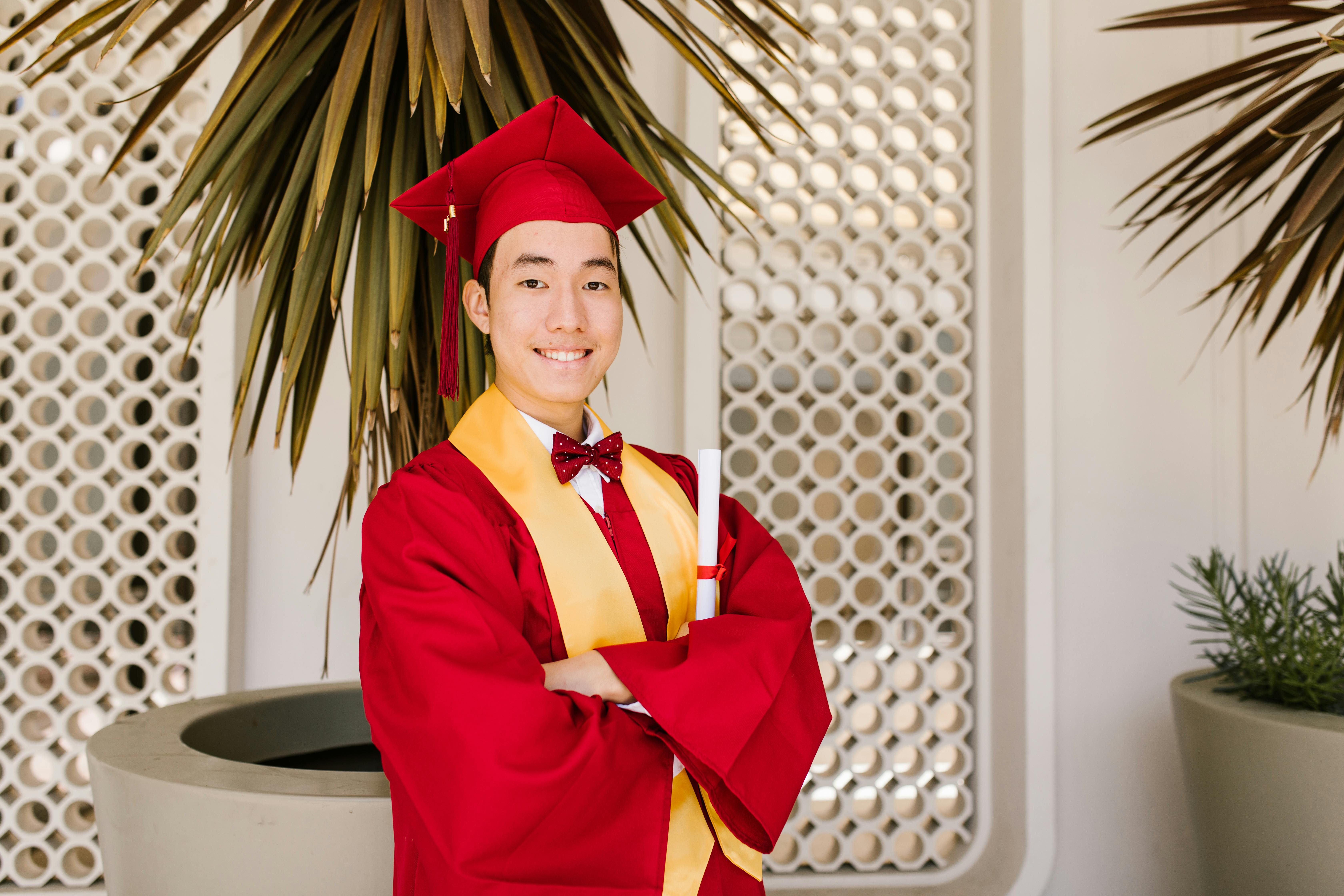 Man in Red Graduation Gown Posing · Free Stock Photo