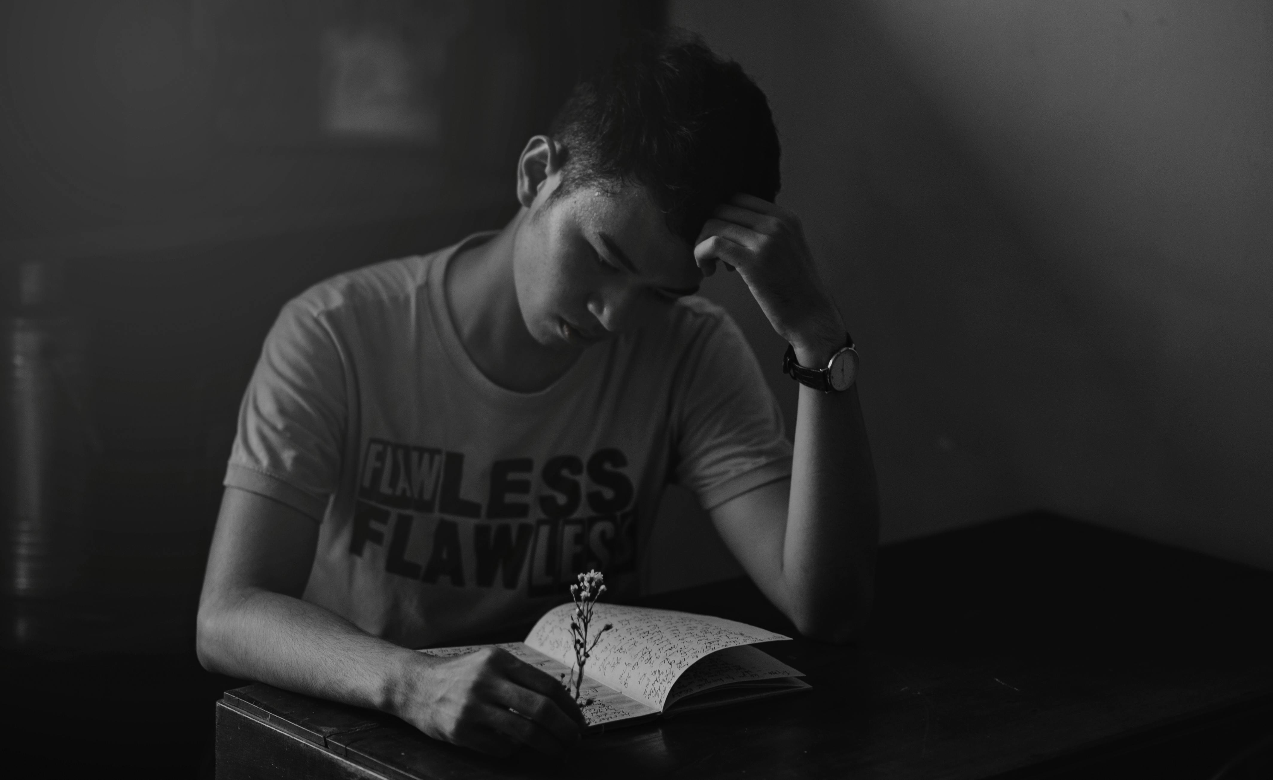 Grayscale Photography of Man in Shirt Reading Notebook · Free Stock Photo