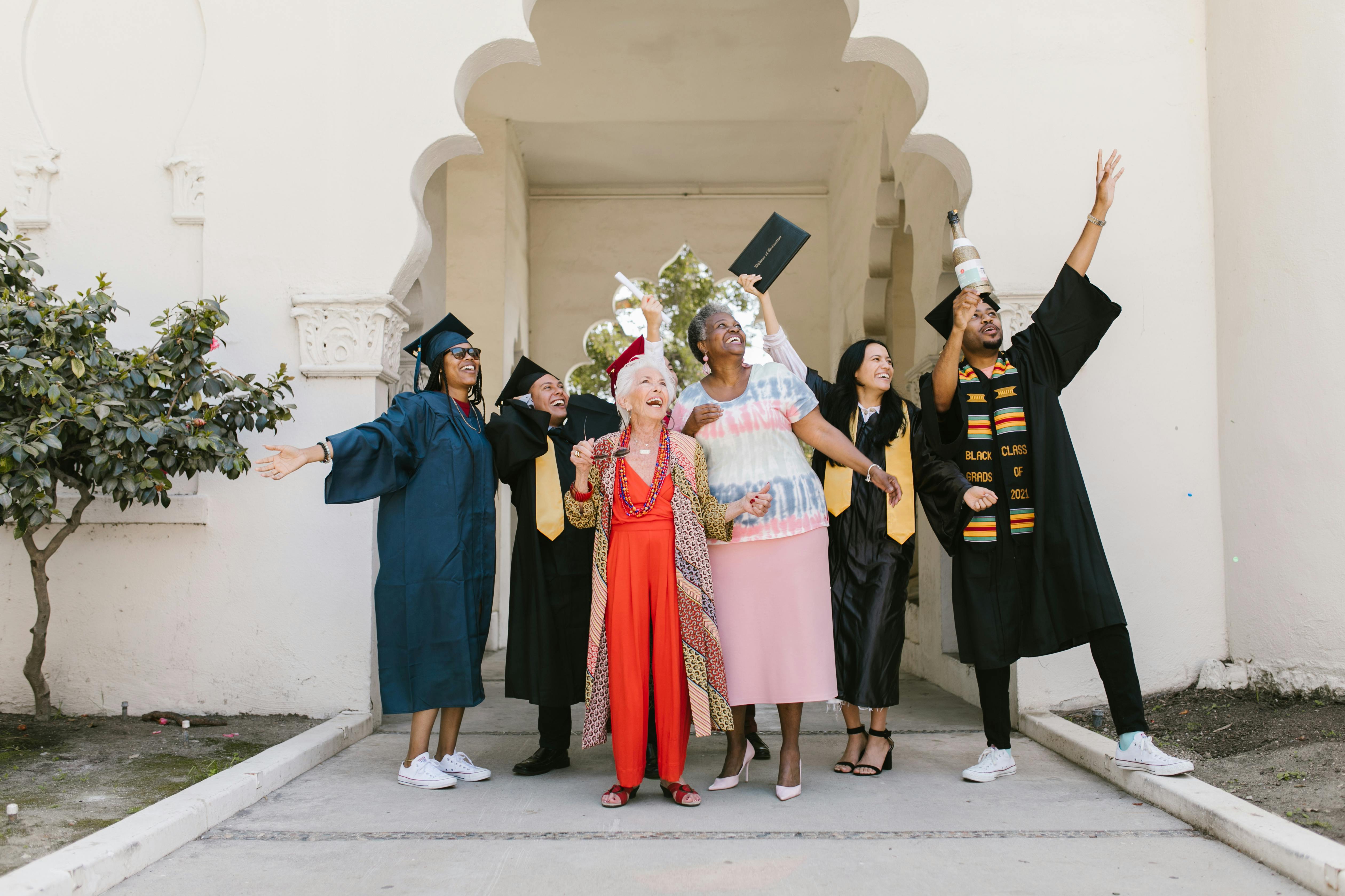 Graduates Celebrating with Elderly Women · Free Stock Photo