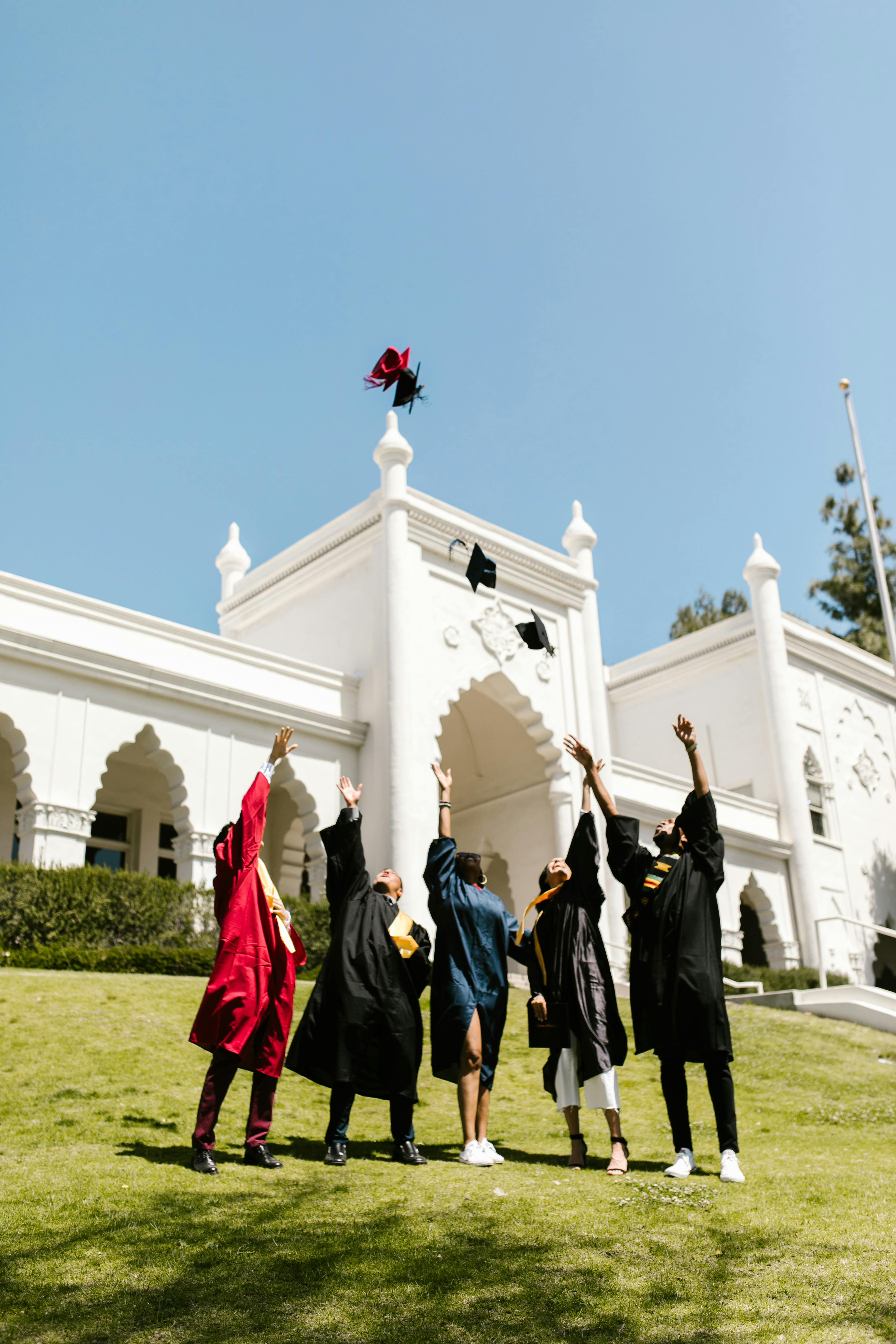 Students Throwing their Graduate Caps into the Air · Free Stock Photo