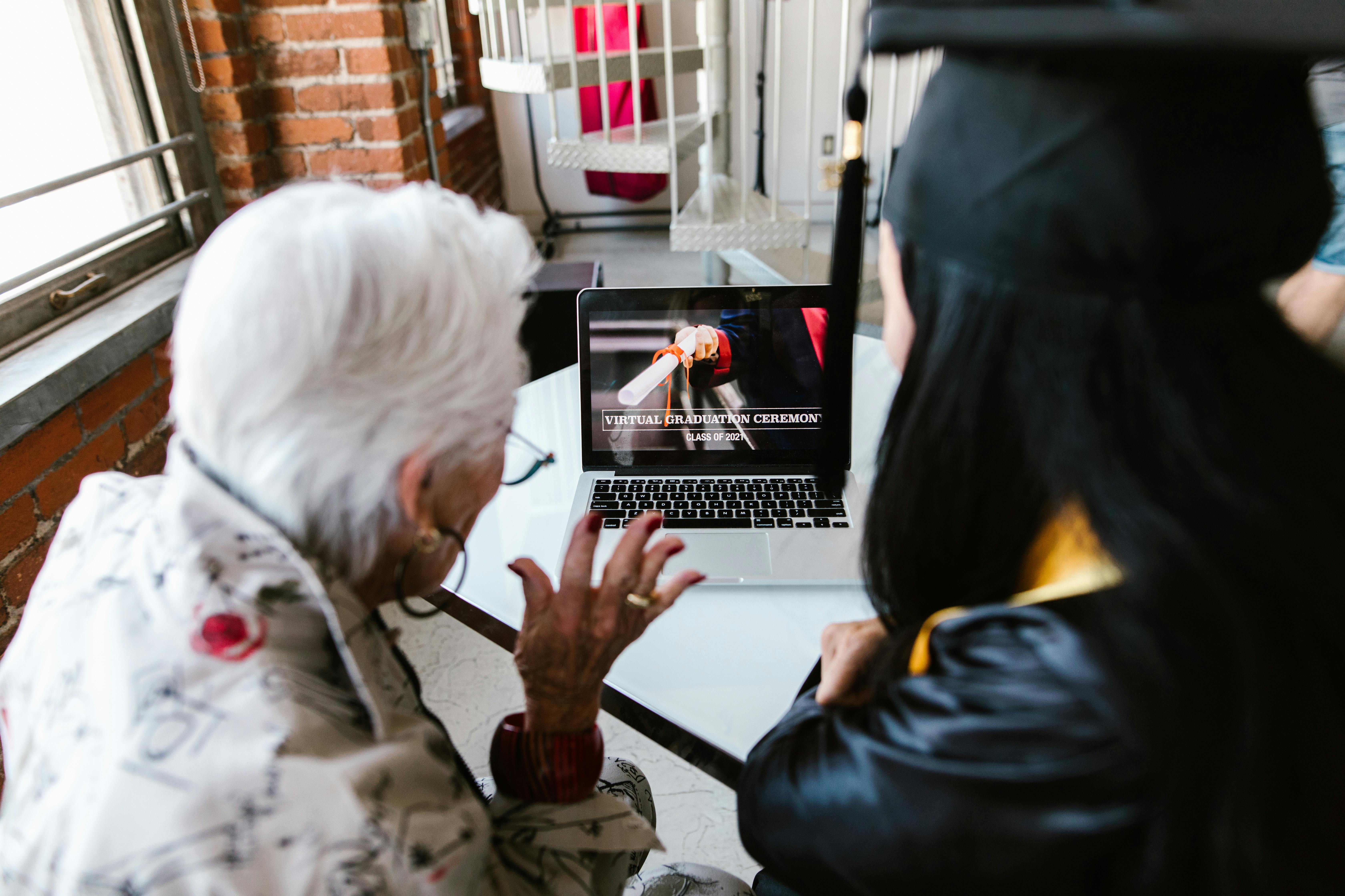 Woman in Black Academic Dress and Elderly Woman Watching Graduation ...