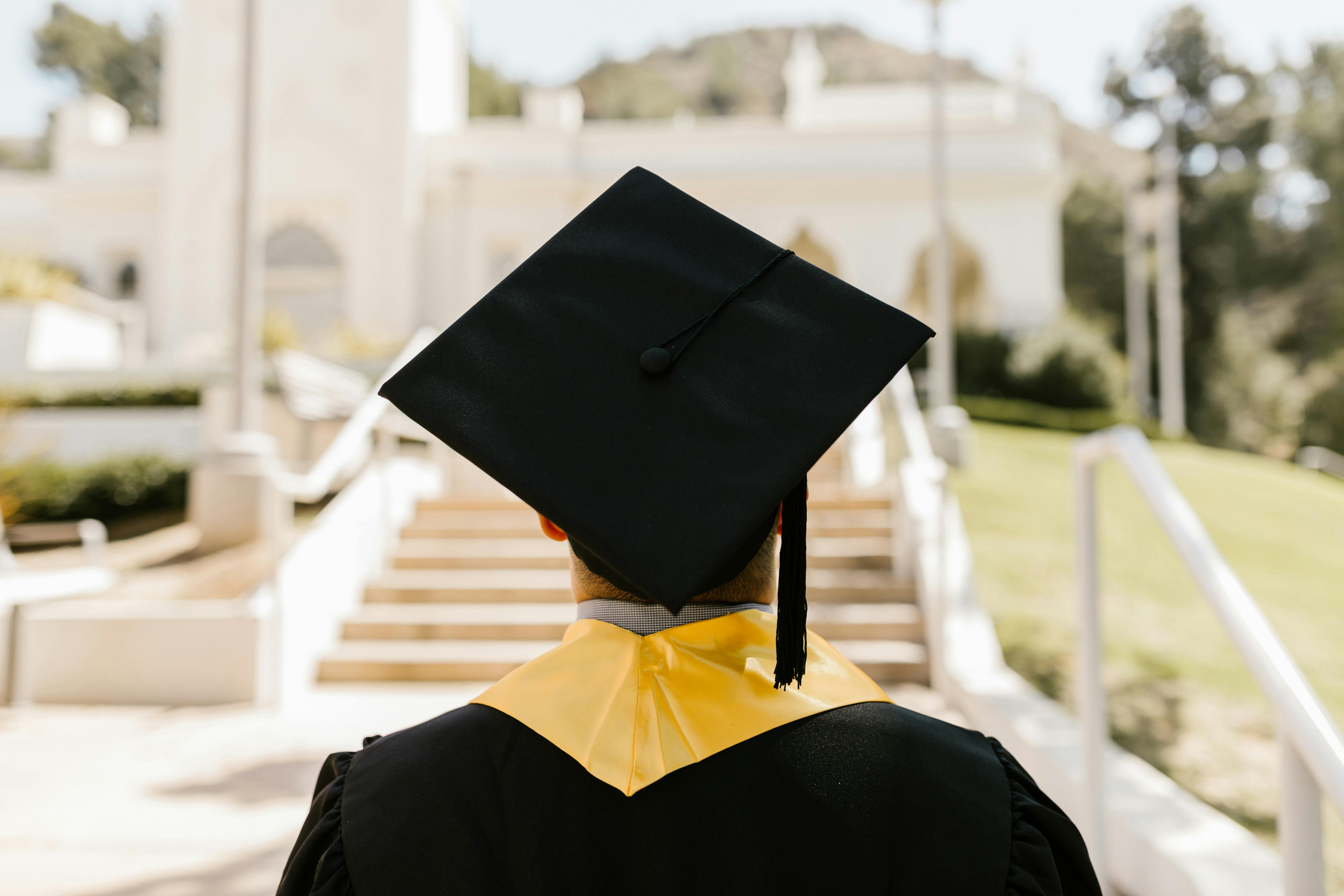 A Graduate Wearing a Mortarboard and a Graduation Gown · Free Stock Photo
