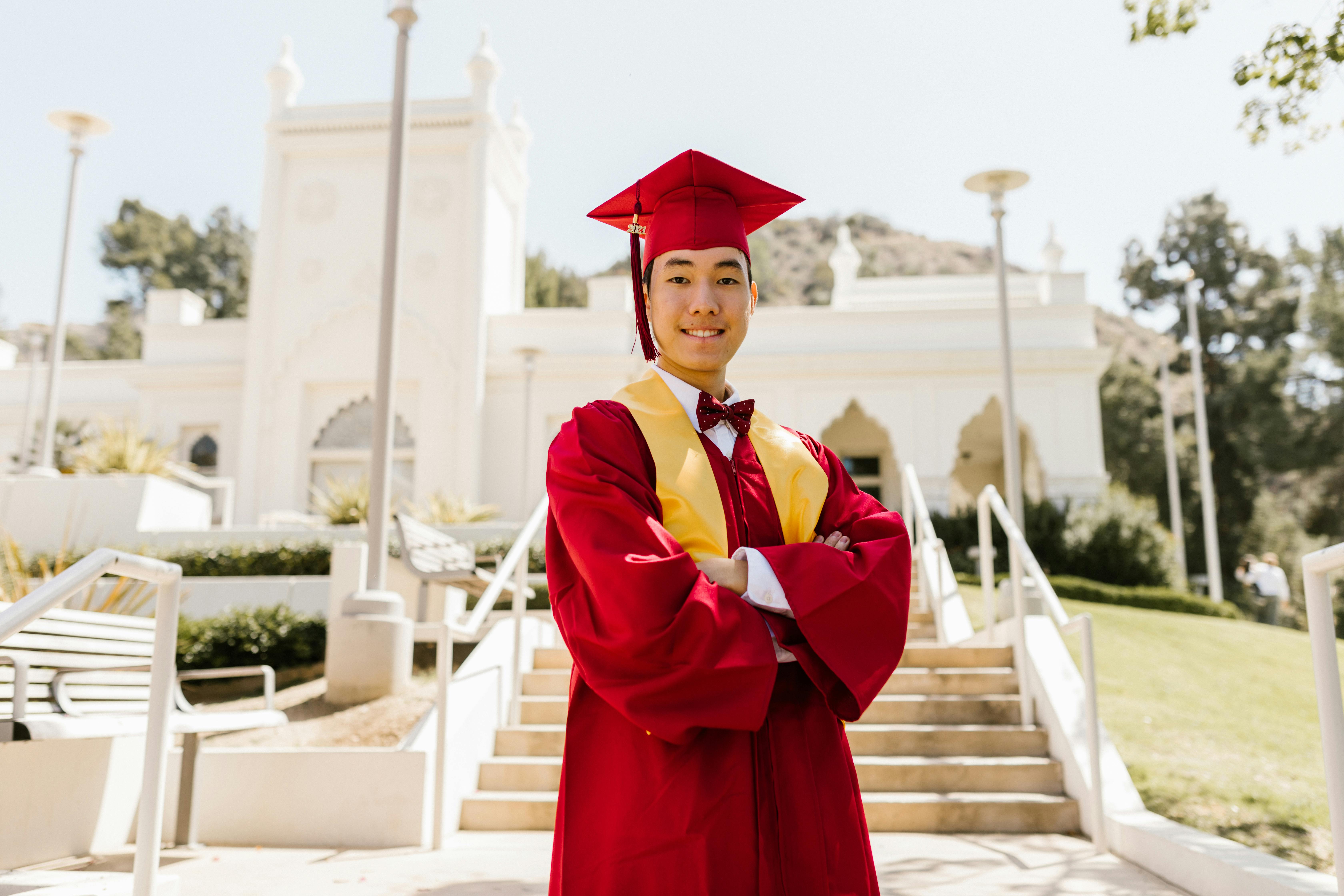 Boy Wearing Red Graduation Gown and Graduation Cap · Free Stock Photo