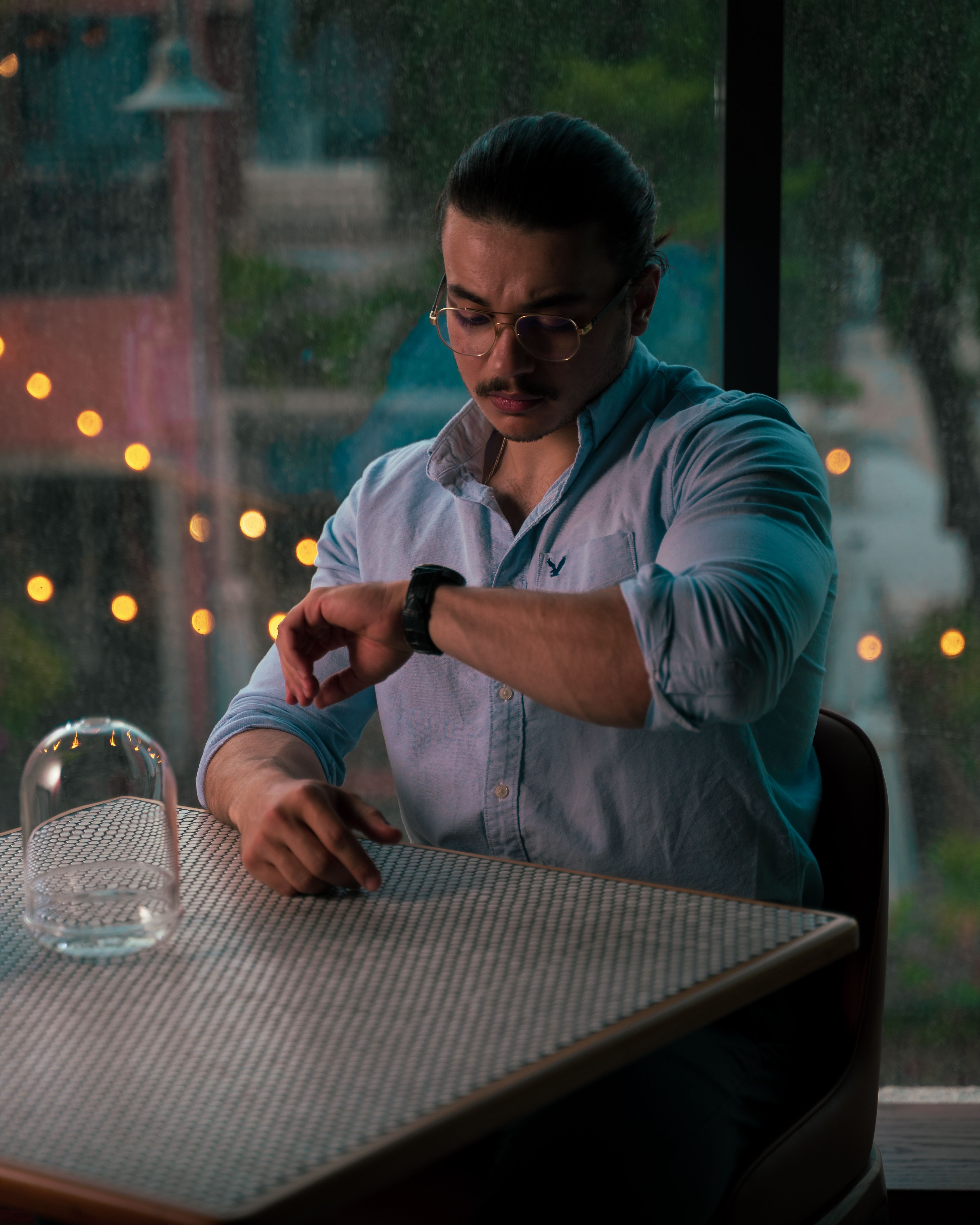 Man in Blue Long Sleeves Looking at His Wristwatch · Free Stock Photo