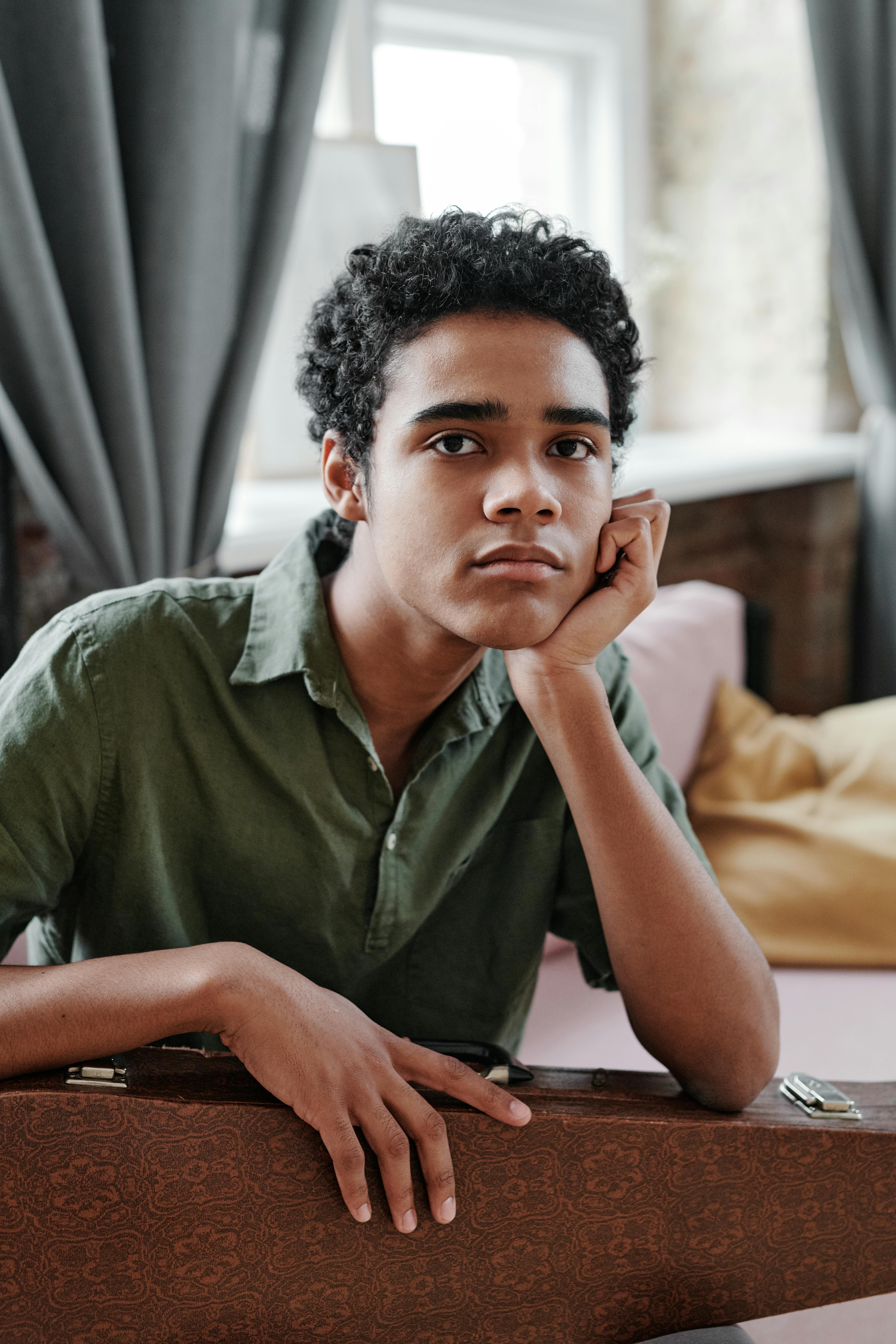 A Young Man Resting his Chin on his Hand · Free Stock Photo