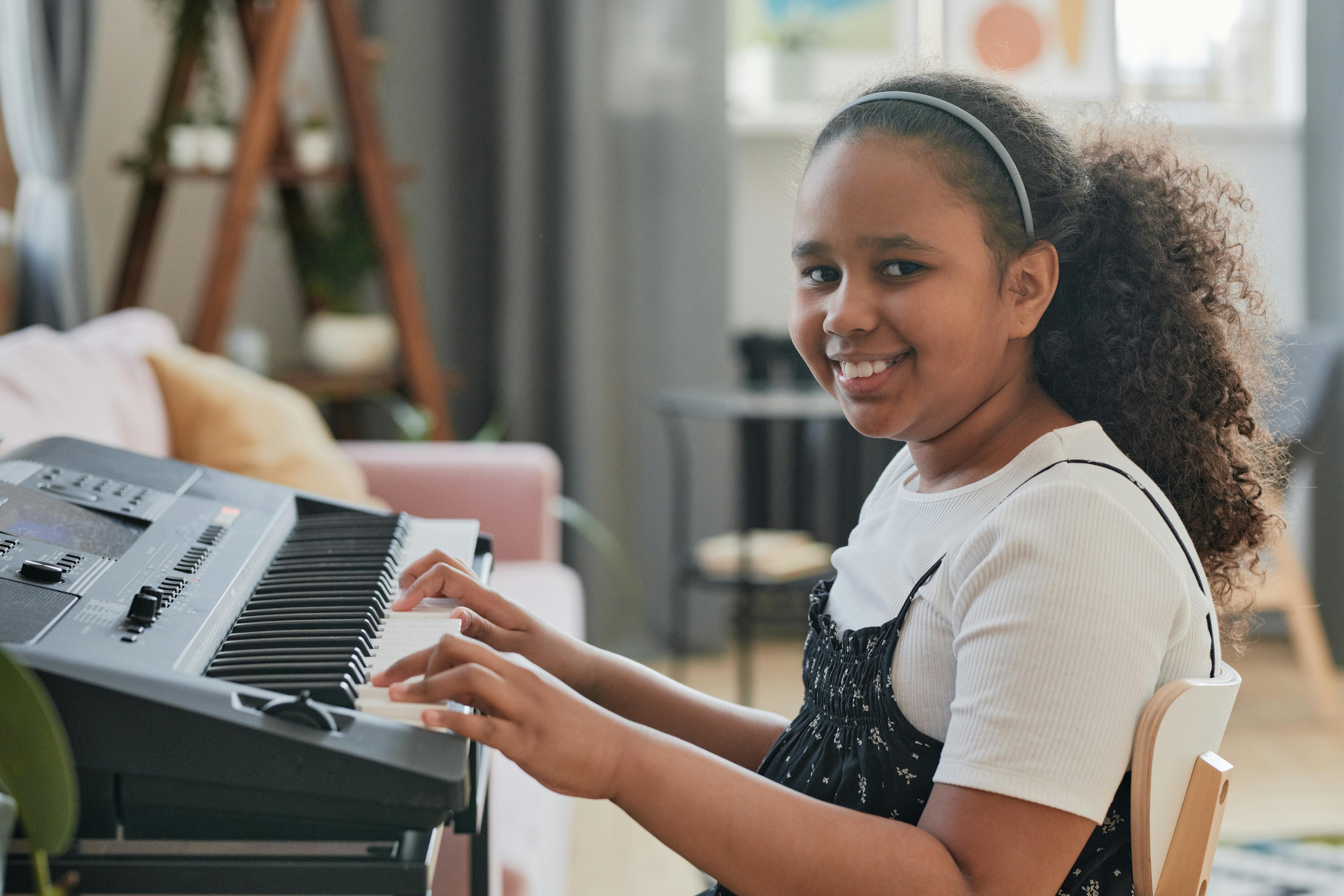 Woman Smiling While Playing Keyboard · Free Stock Photo
