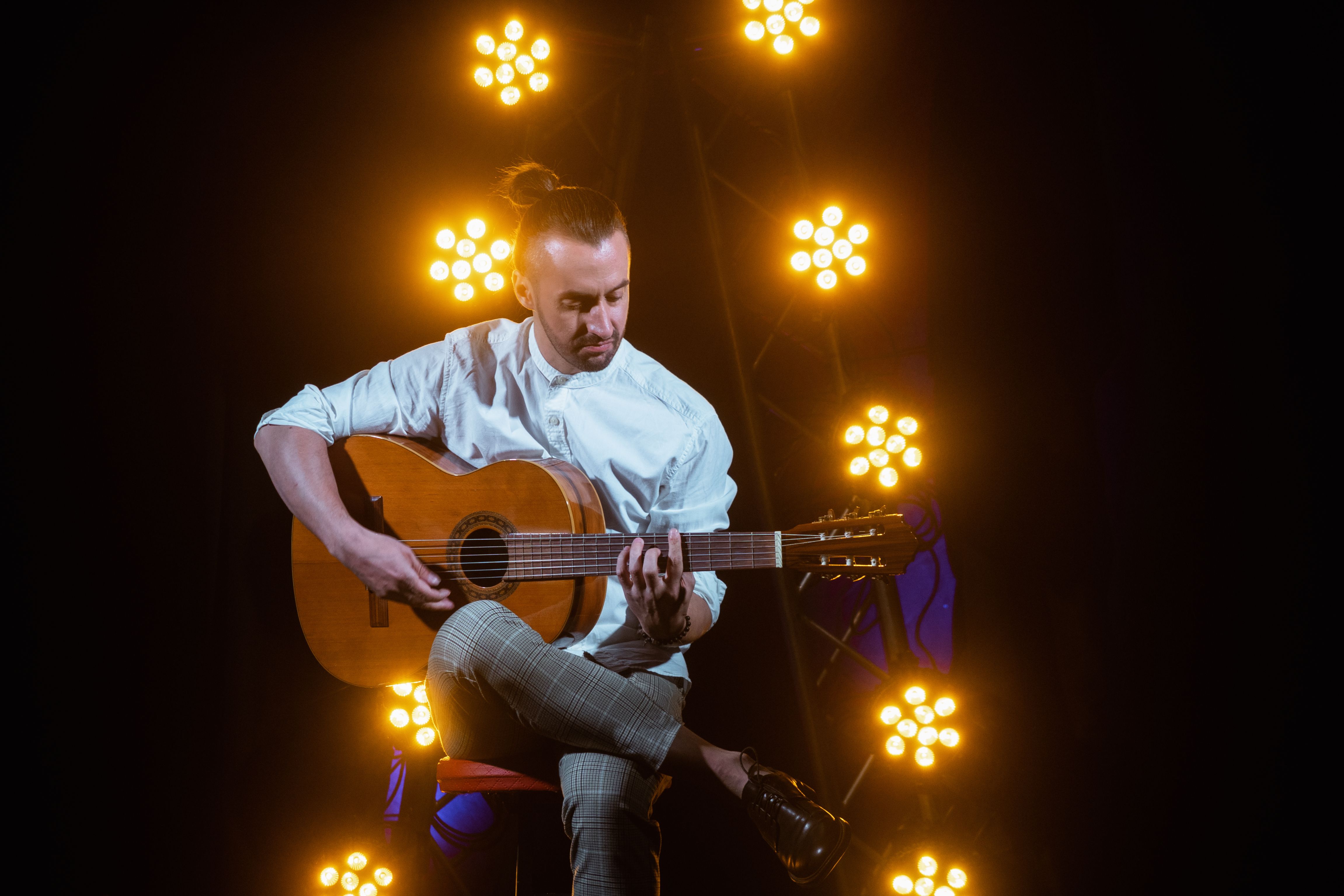 Person Holding an Acoustic Guitar · Free Stock Photo