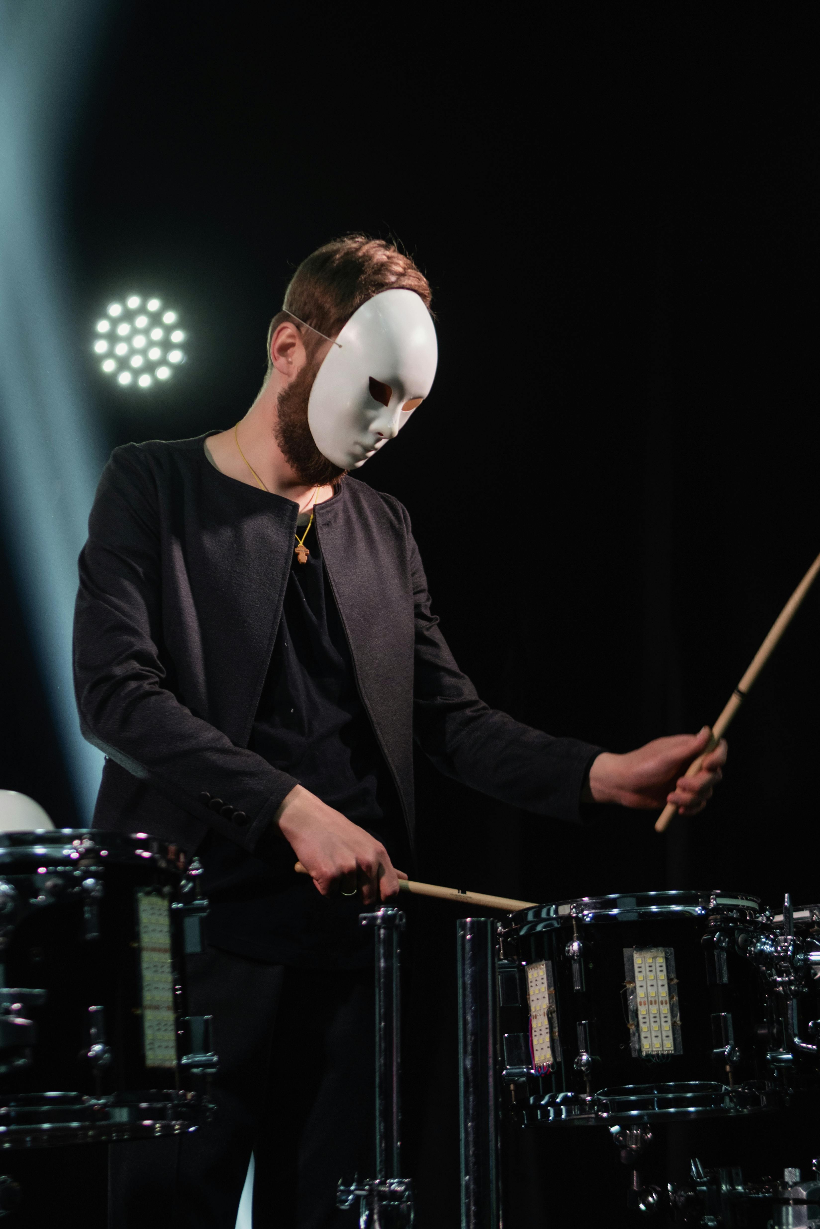 A Man in Black Suit Jacket Playing Drum Set · Free Stock Photo