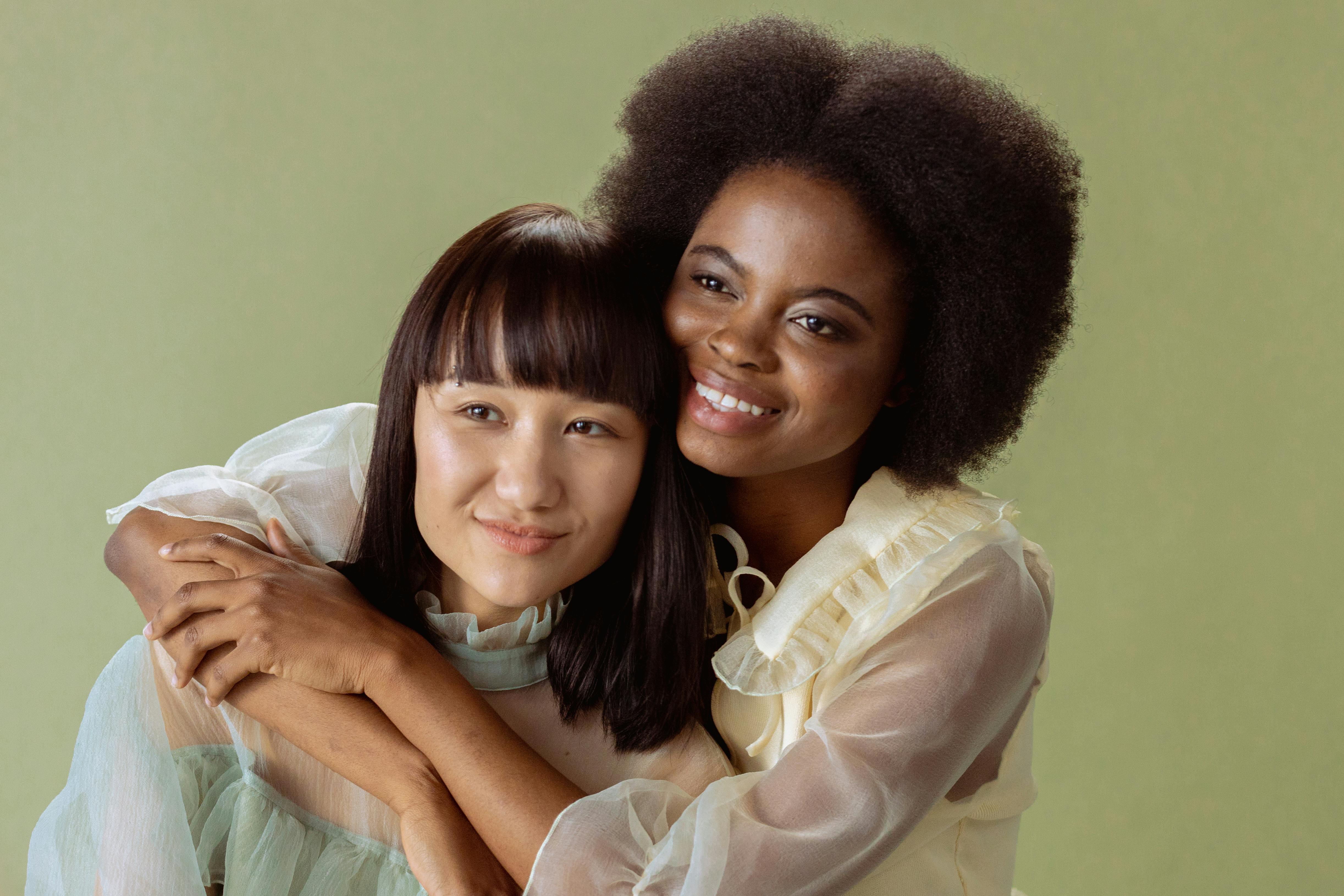 Portrait of Two Women Wearing Chiffon Ruffled Blouses · Free Stock Photo