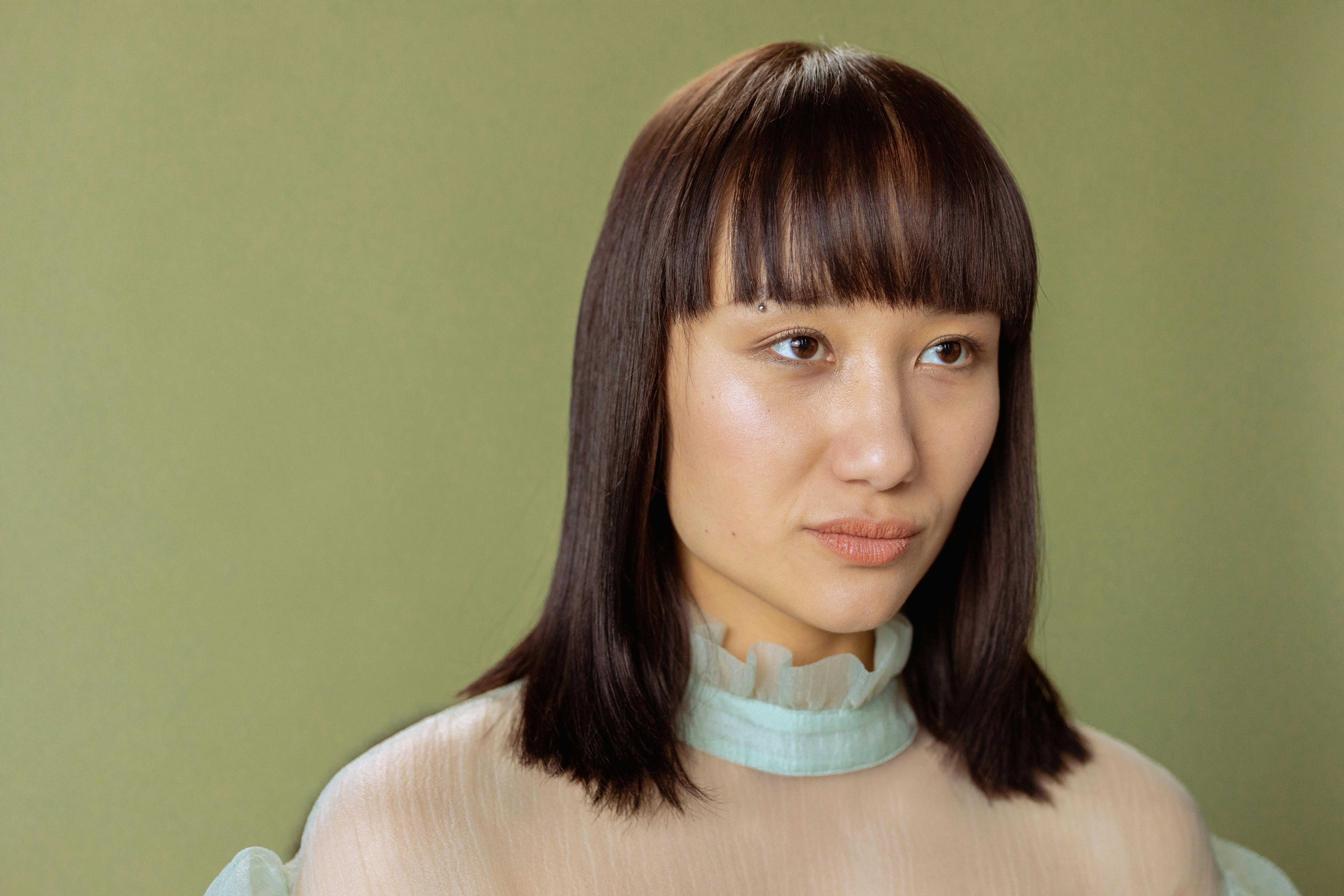 Close-Up Photograph of a Woman with Bangs · Free Stock Photo