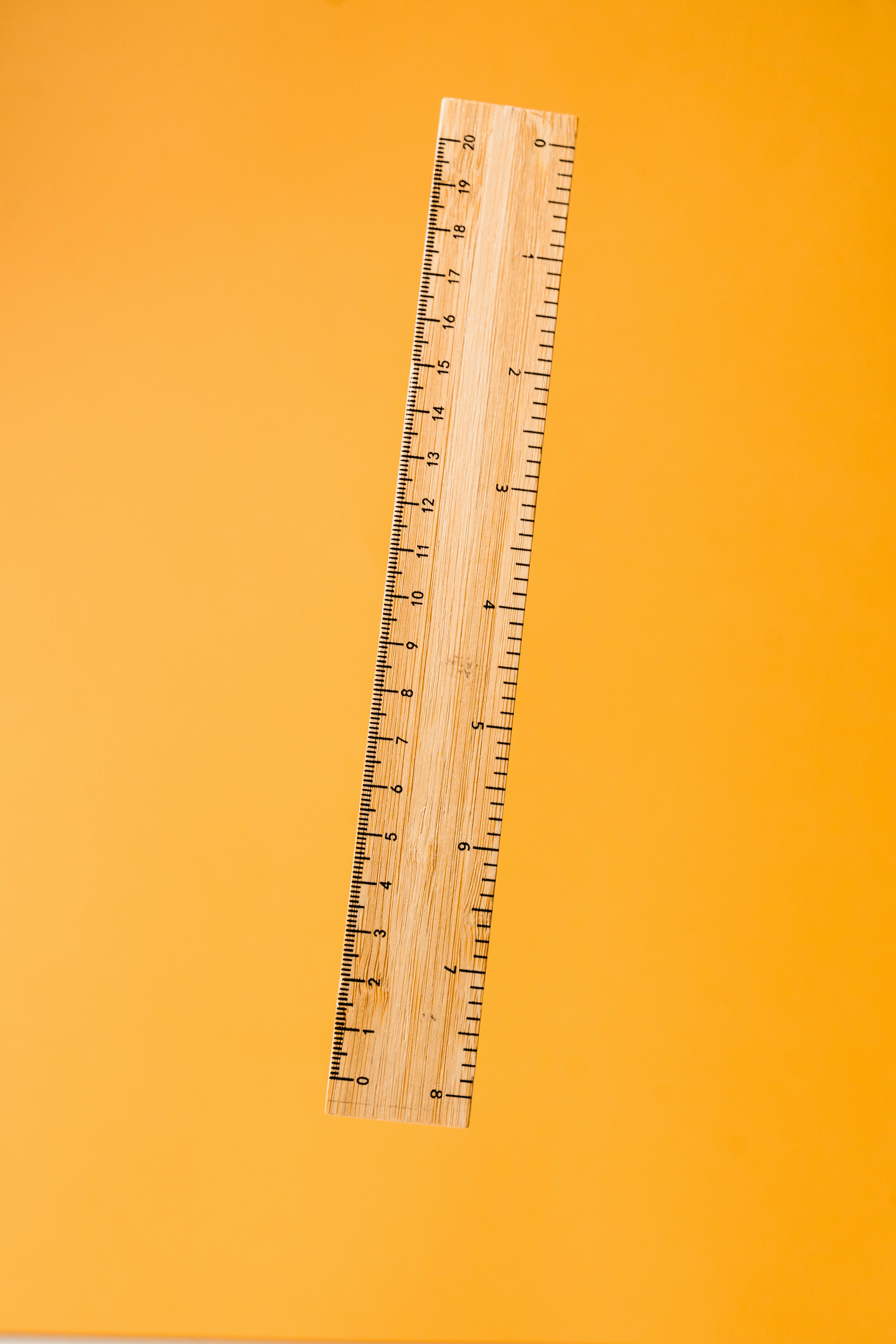 Assorted Rulers Beside a Black Paper · Free Stock Photo