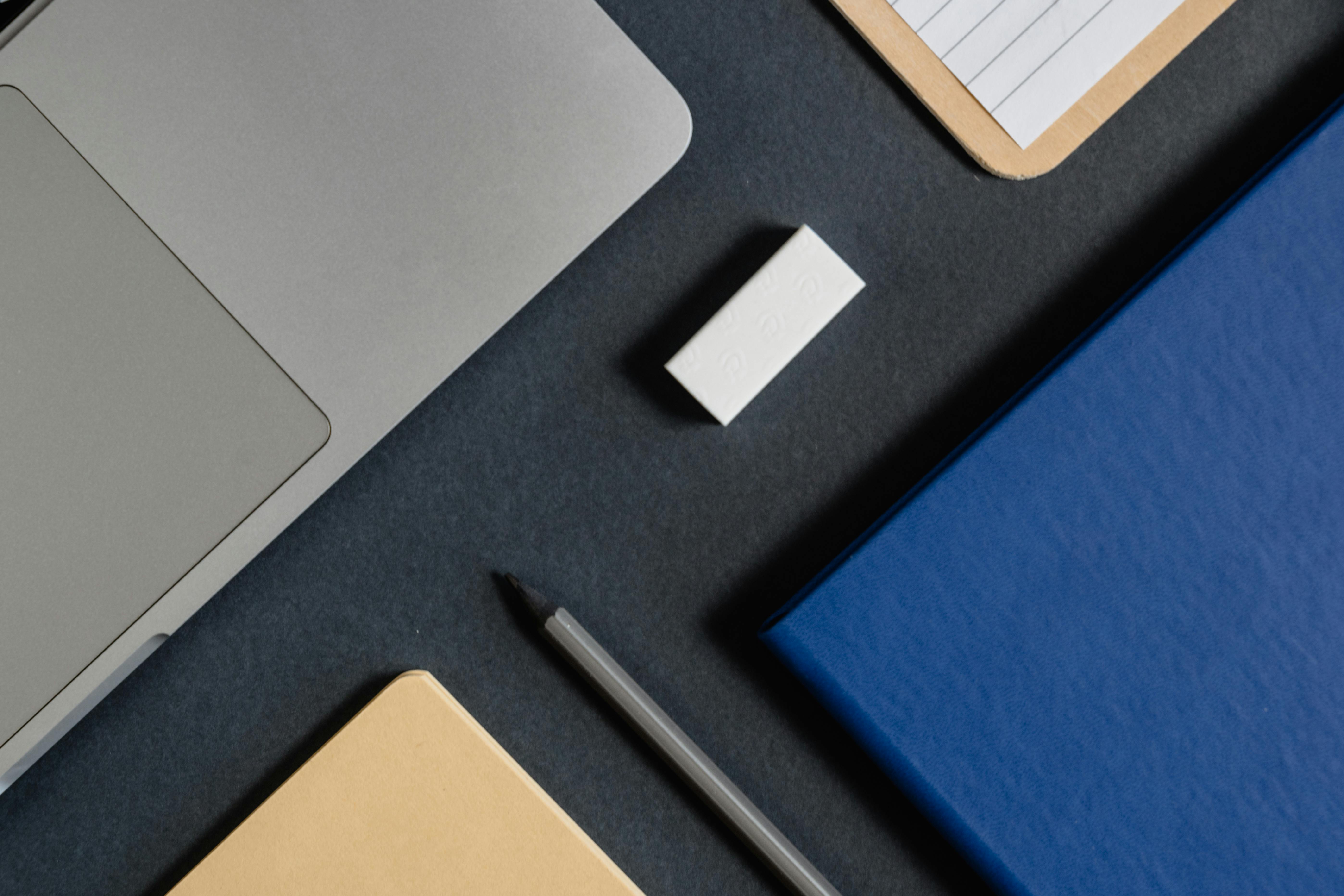 Black Iphone Beside Silver Pen on White Notebook Near Laptop Computer ...