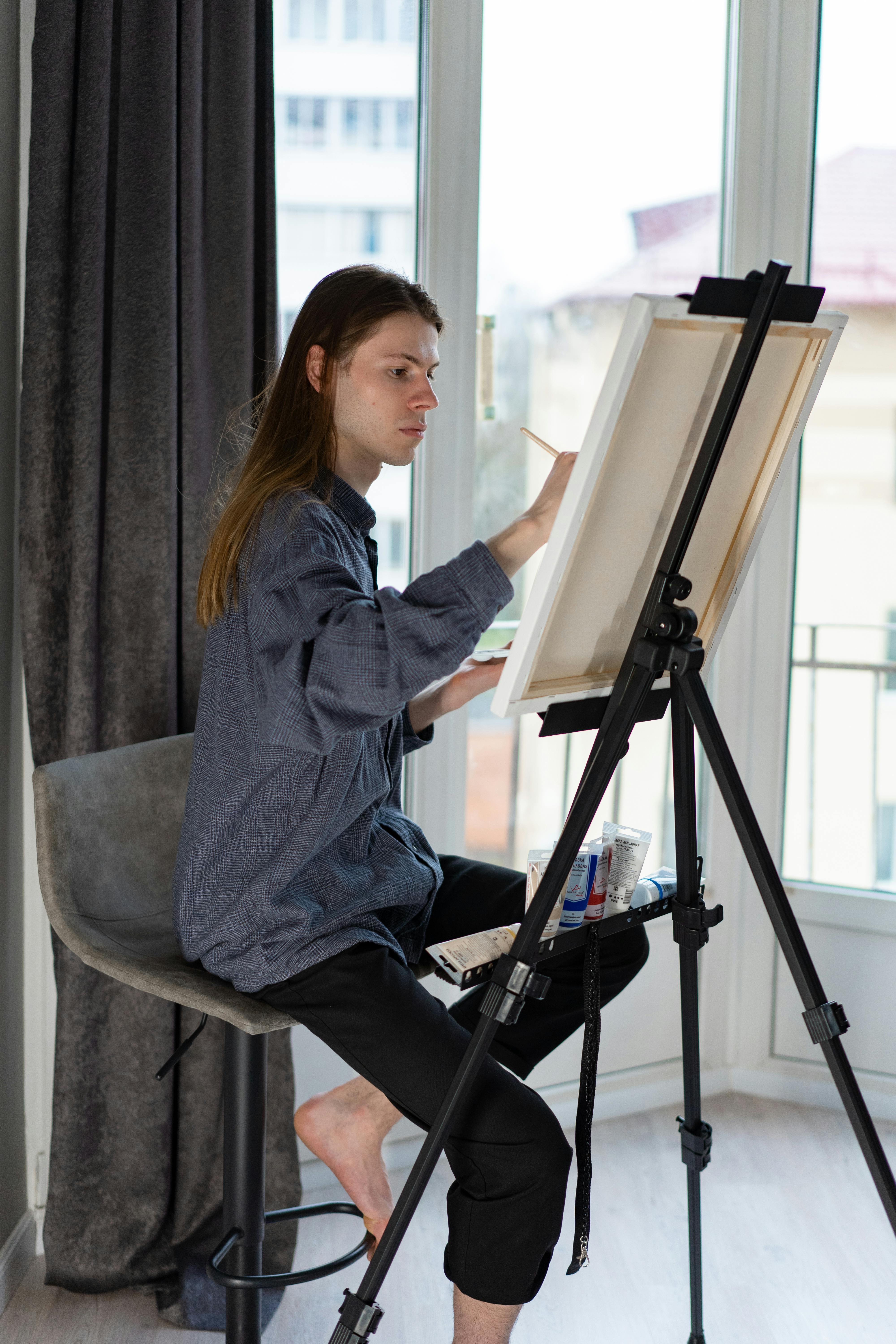 A Man Painting on a Canvas · Free Stock Photo