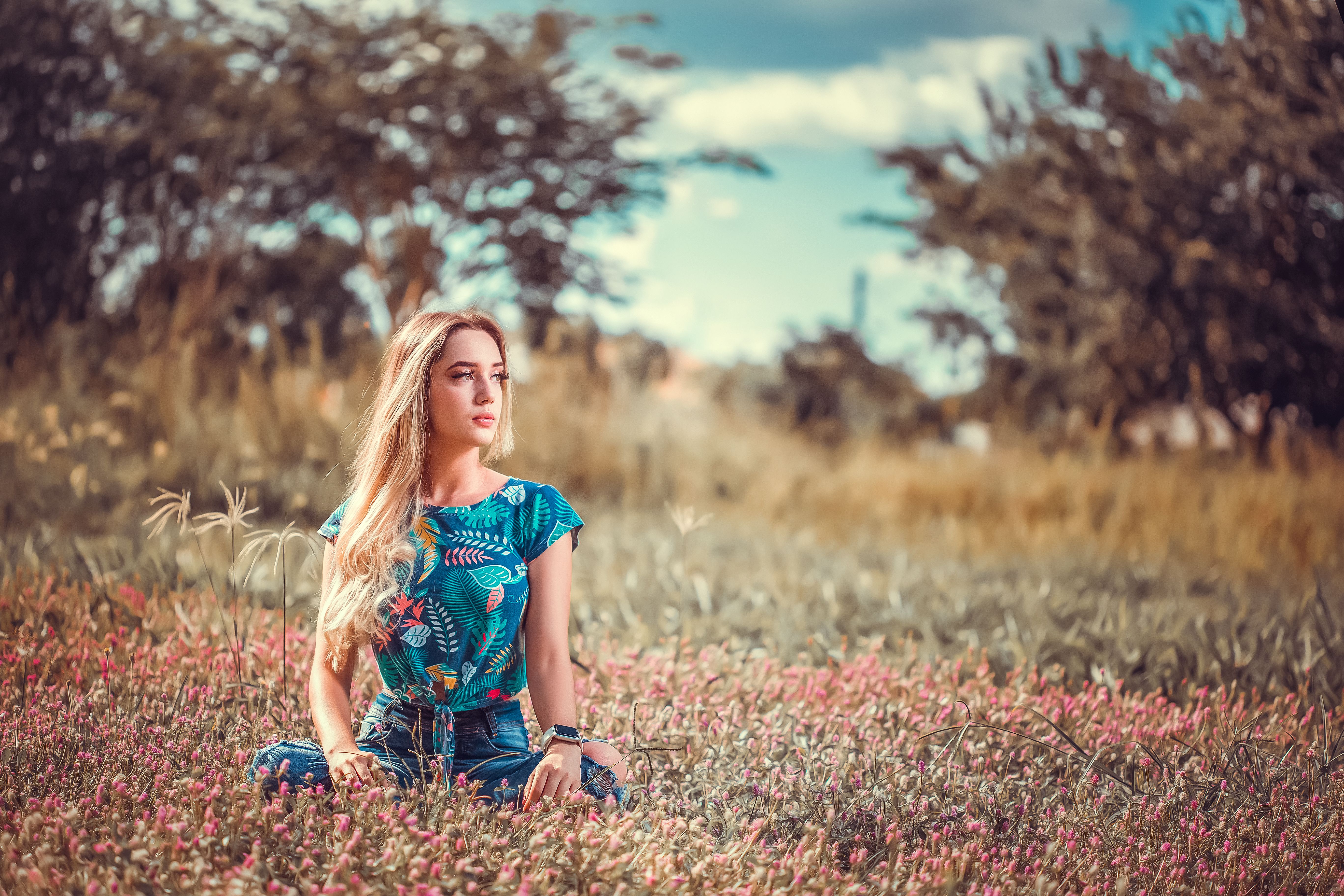 A Woman Sitting on a Flower Field · Free Stock Photo
