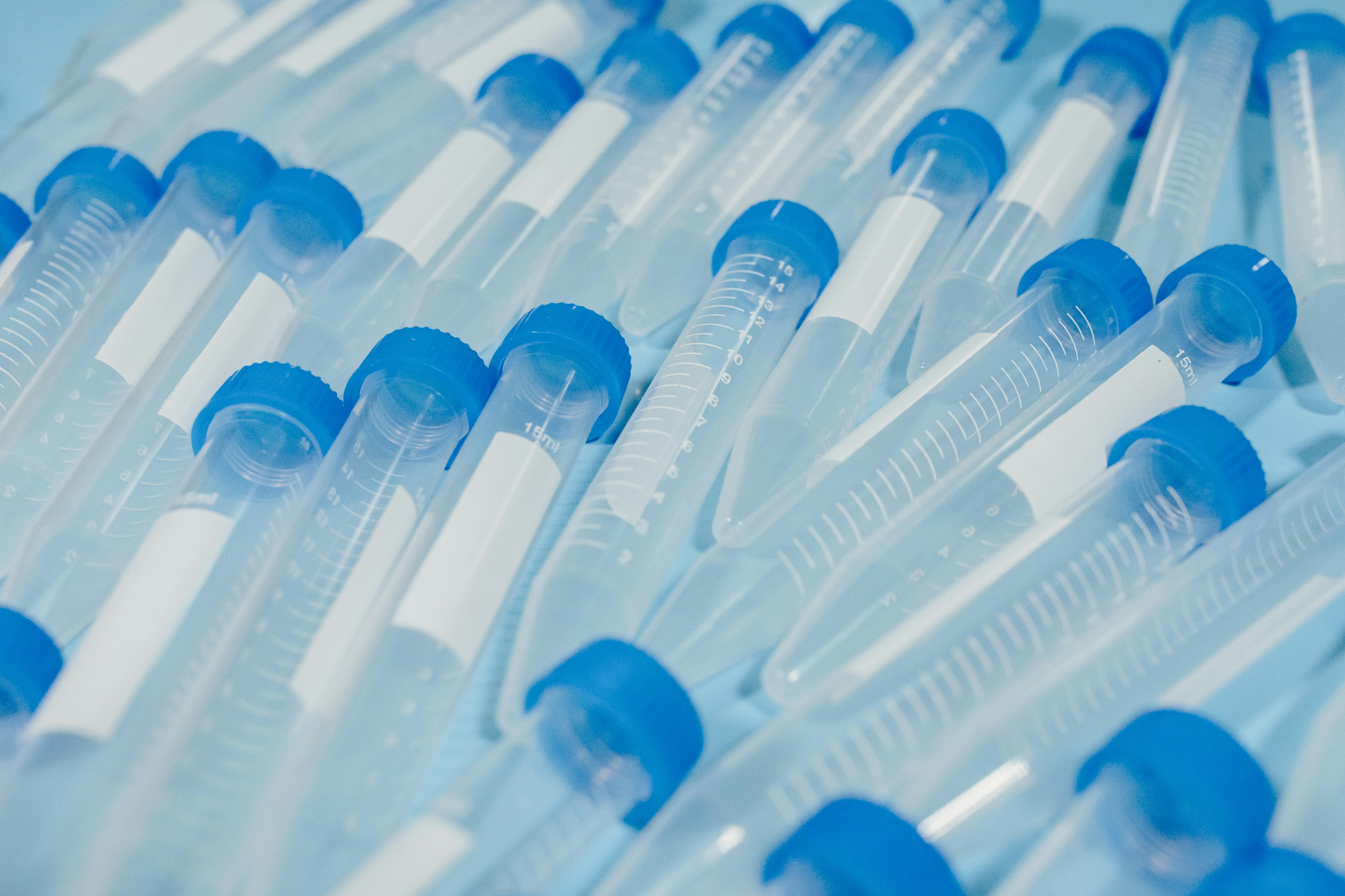 A Collection of Blue Cap Plastic Test Tubes · Free Stock Photo
