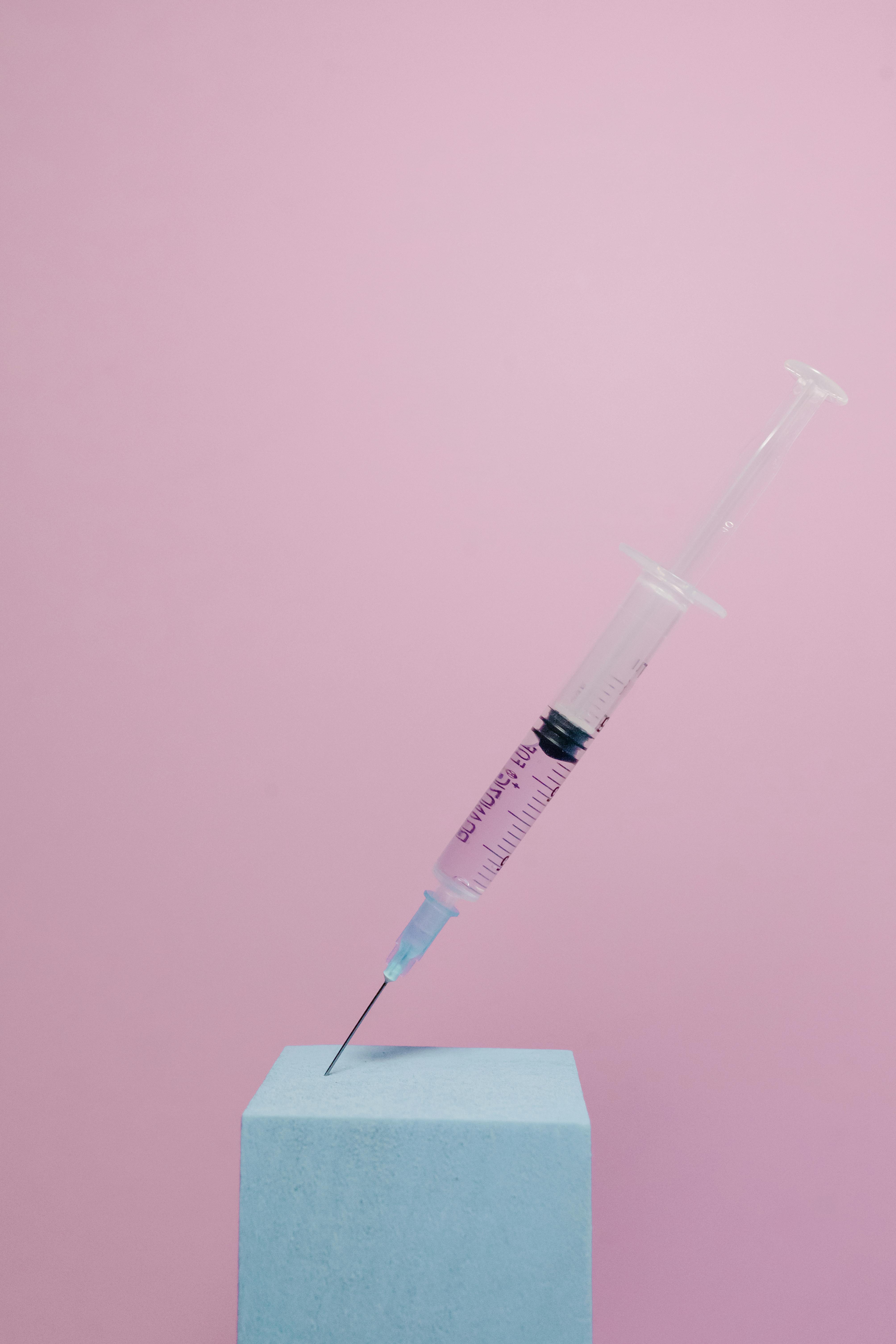 A Syringe in Pink Background · Free Stock Photo