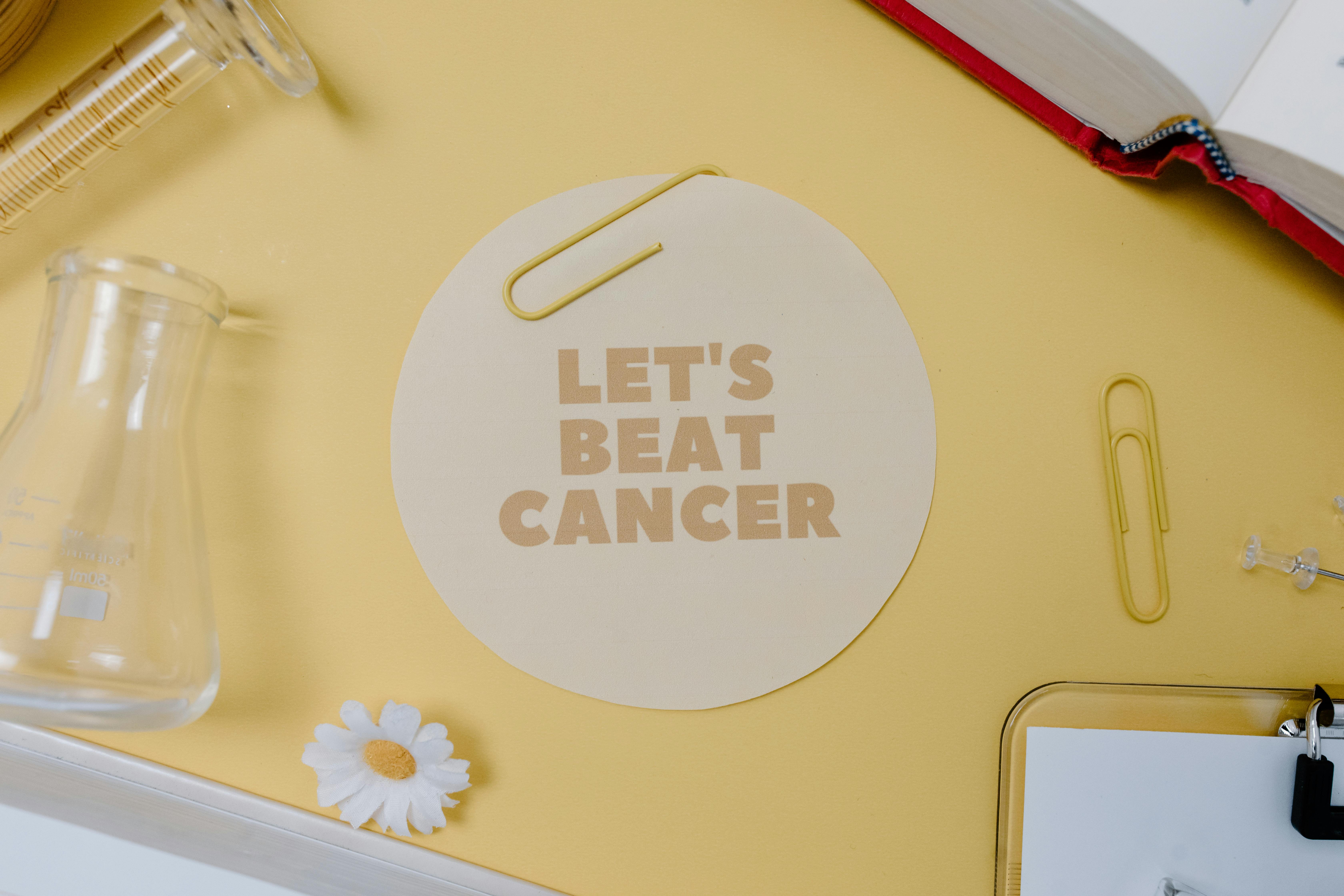 Let's Beat Cancer Slogan on a Round Paper · Free Stock Photo