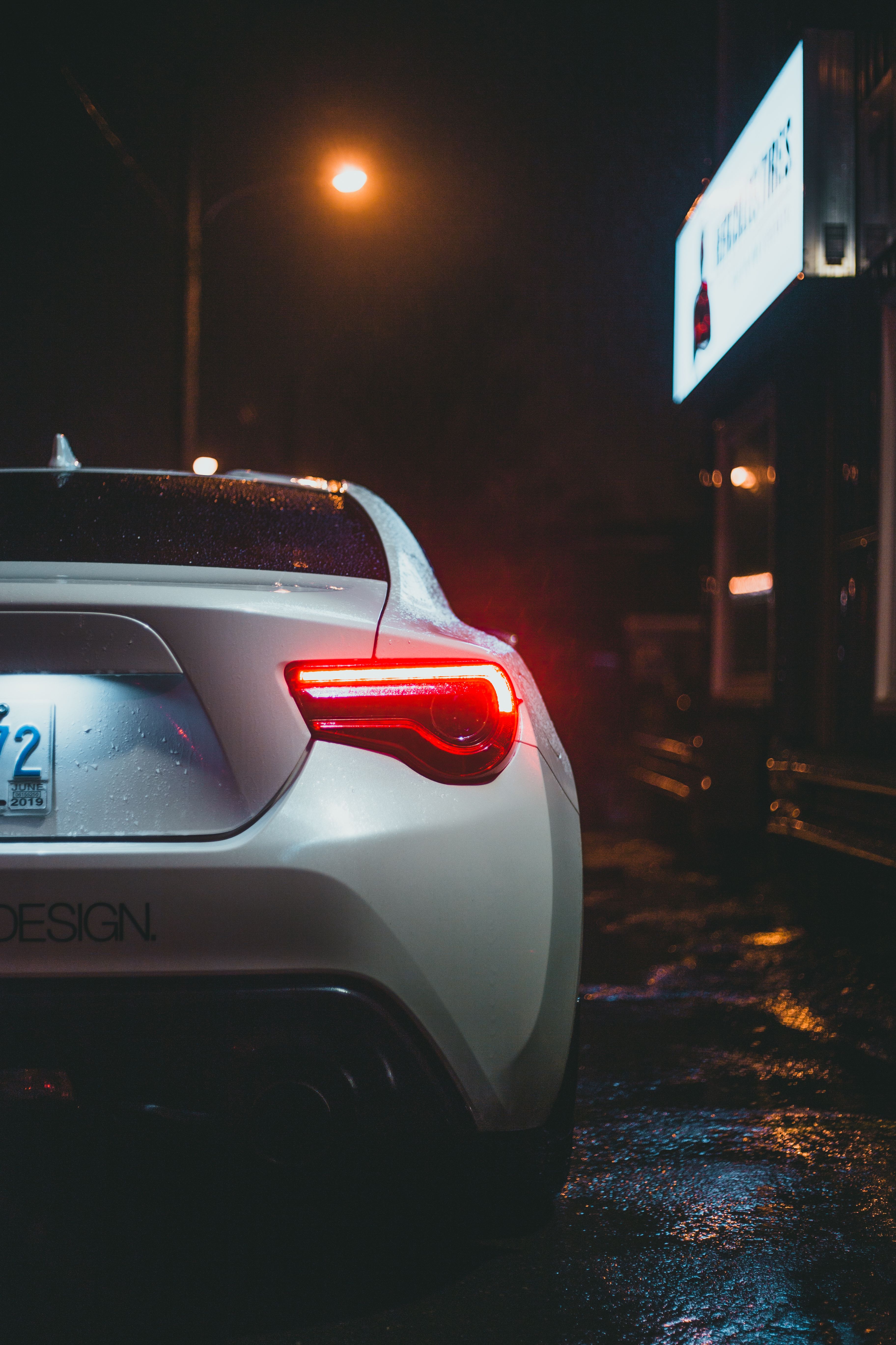 White Car in Front of Store during Night Time · Free Stock Photo